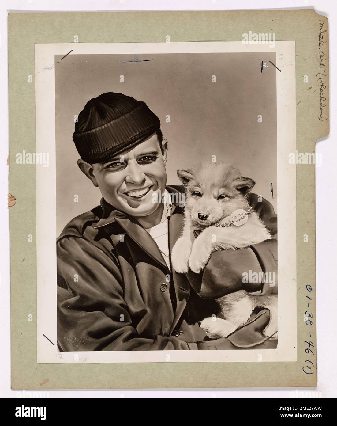 A Coast Guardsman is shown in a portrait with his dog, named Snafu. The ...