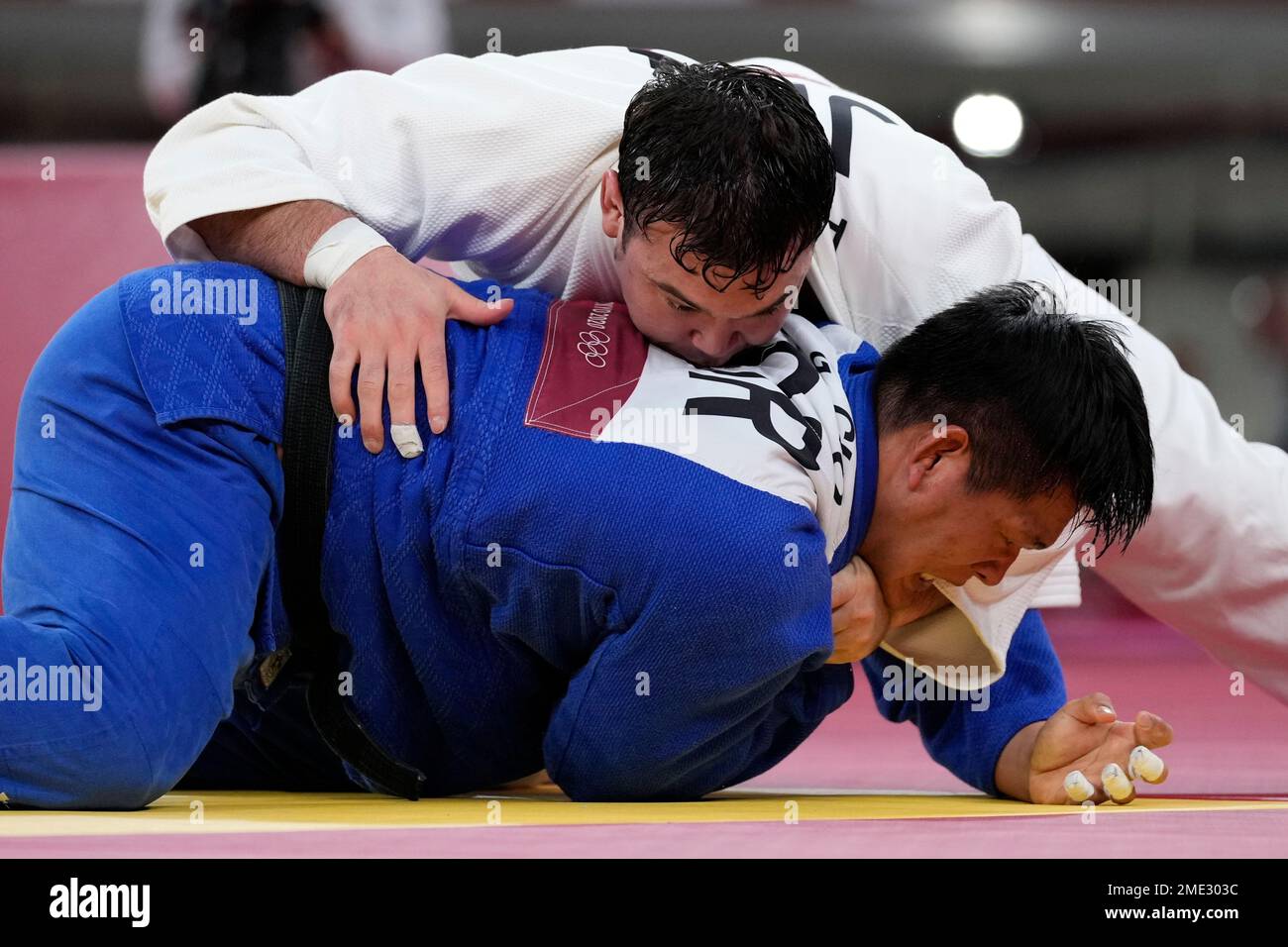 Aaron Wolf of Japan, top, and Cho Gu-ham of South Korea compete in the ...