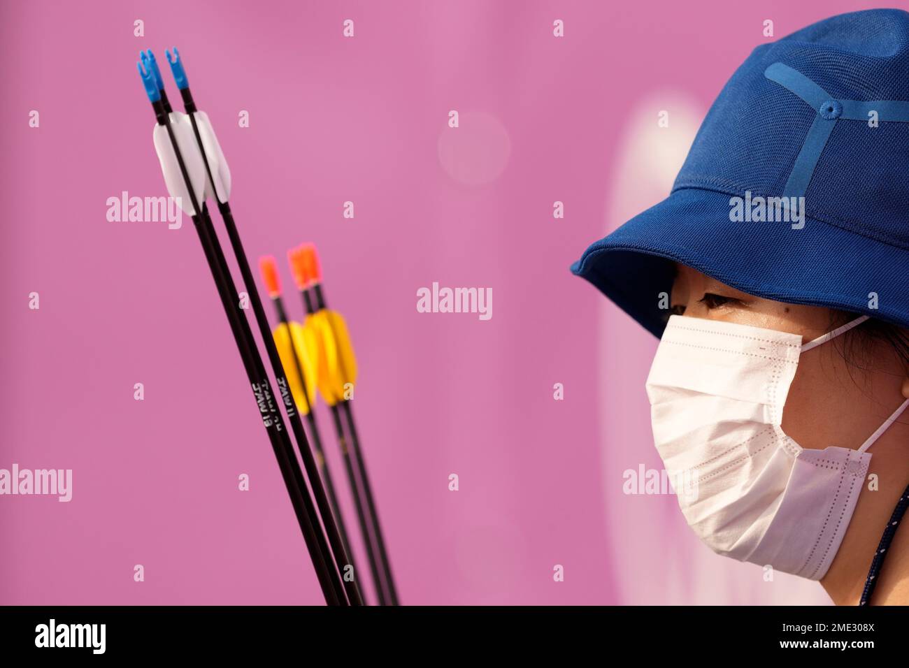 A volunteer holds arrows during the individual eliminations at the 2020 ...