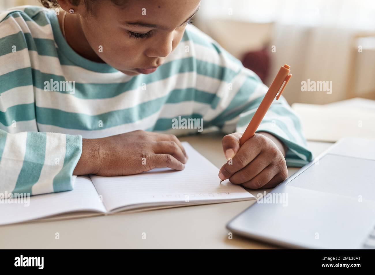 Black girl writing hi-res stock photography and images - Alamy