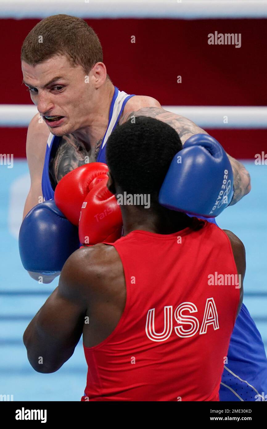 Troy Isley, from the United States, bottom, exchanges punches with Gleb ...