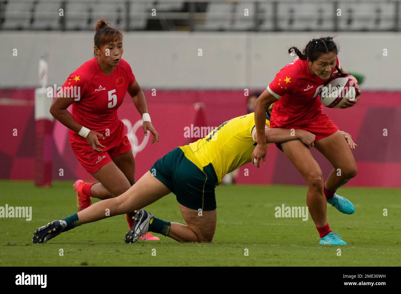 China's Wang Wanyu is tackled by Australia's Shannon Parry, in their ...