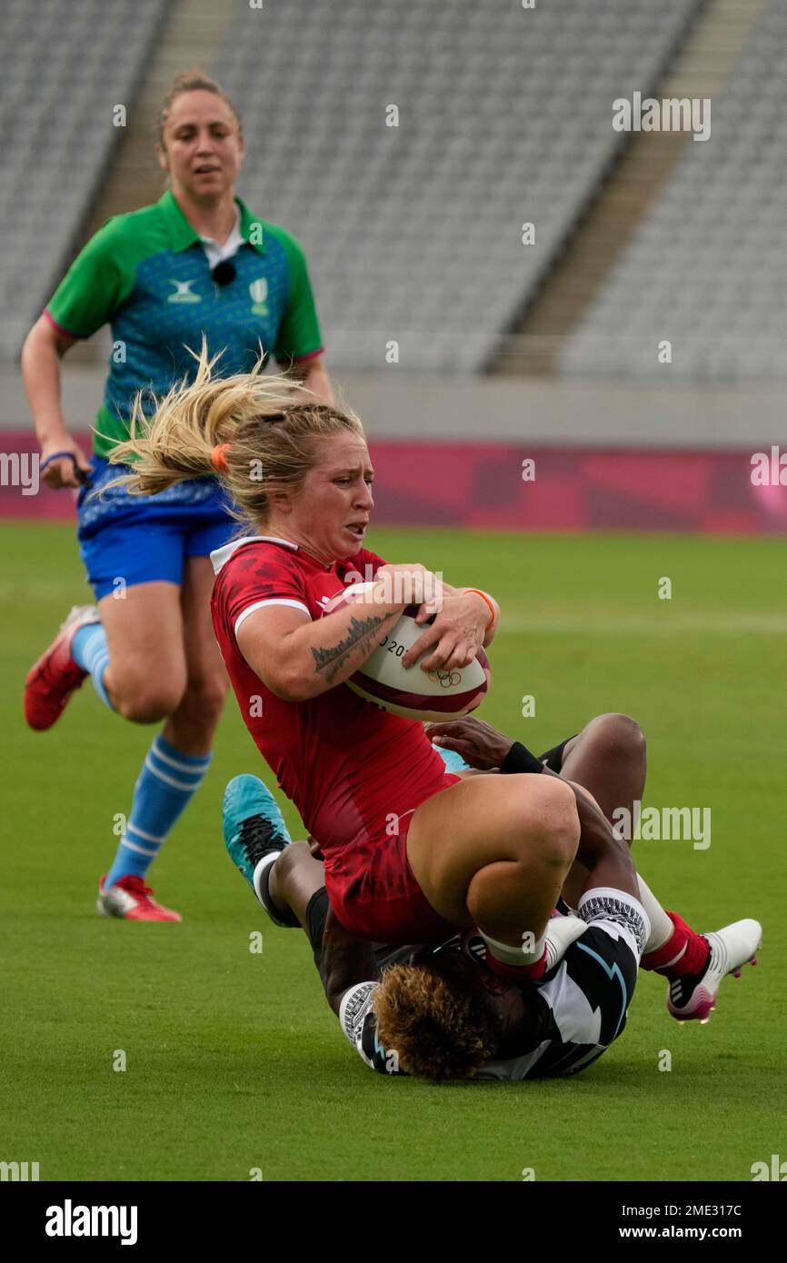 Canada's Kayla Moleschi is brought down by Fiji's Roela Radiniyavuni in ...