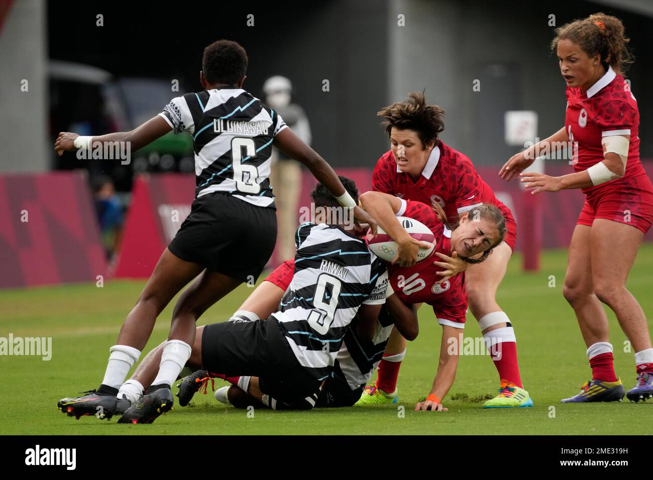 Canada's Kaili Lukan, center, is tackled by Fiji's Viniana Riwai, as ...