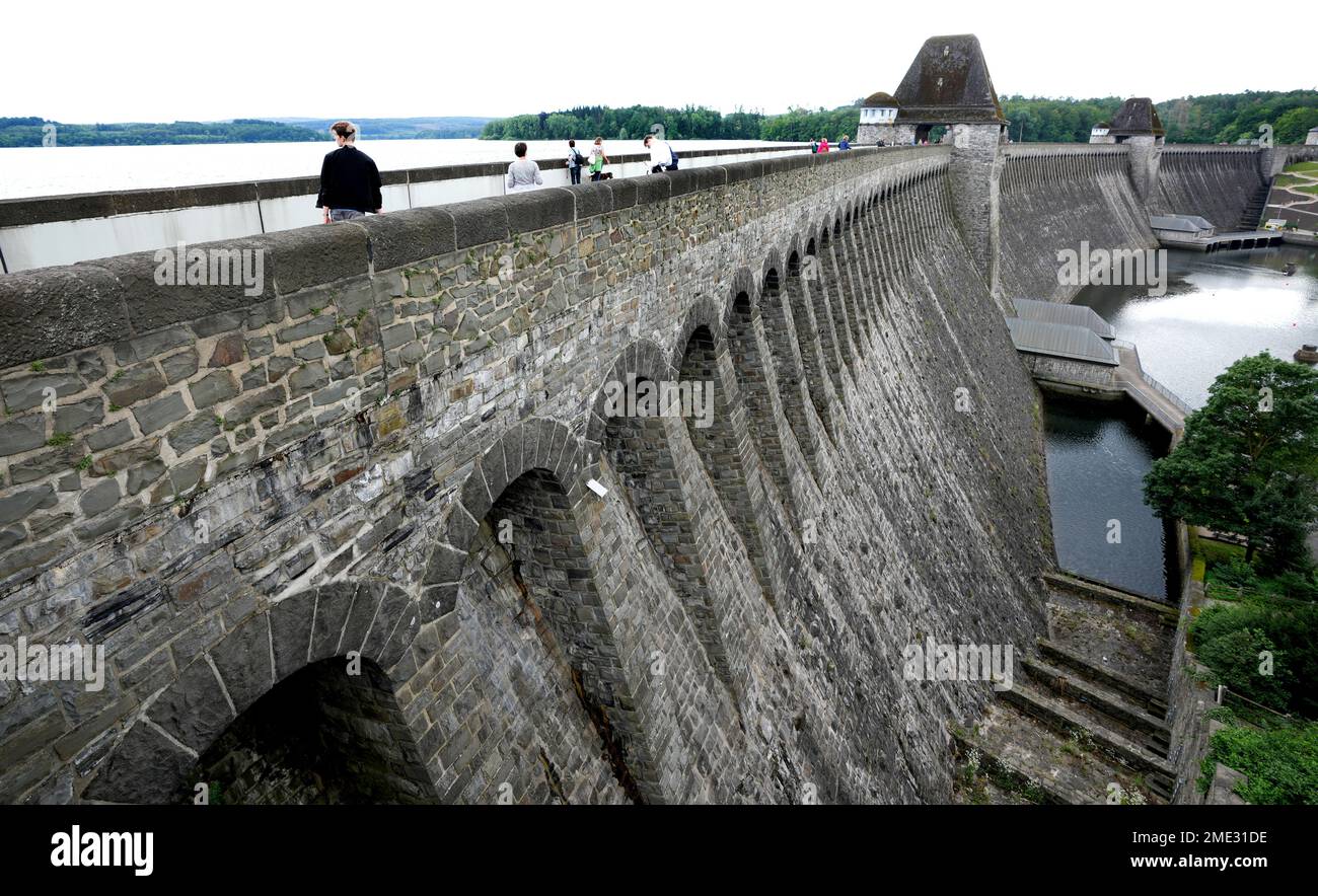 People walk on the dam wall of the Moehnesee (Lake Moehne) dam in ...