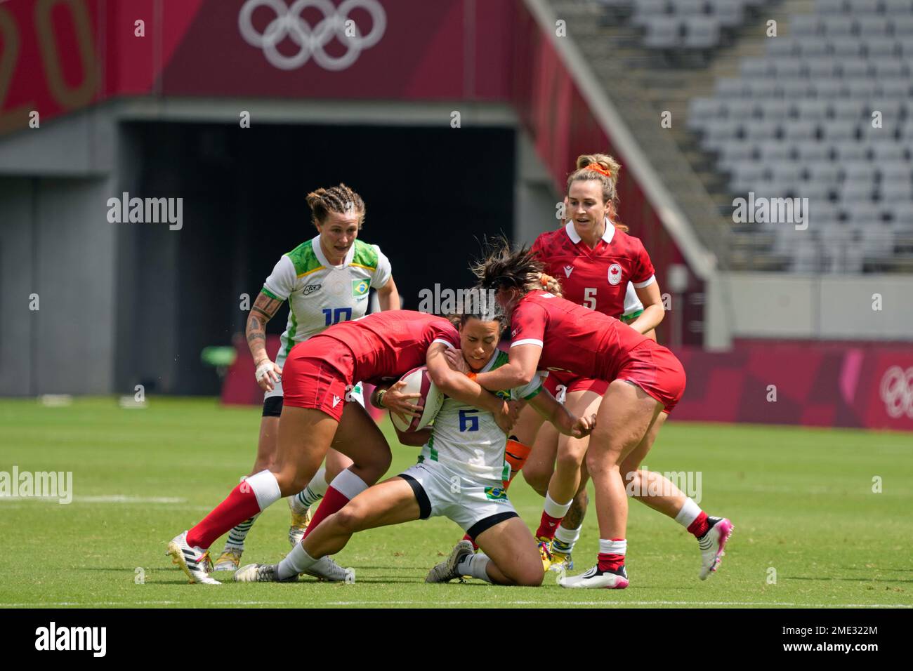 Brazil's Isadora Cerullo, center, is tackled by Canada's Ghislaine ...