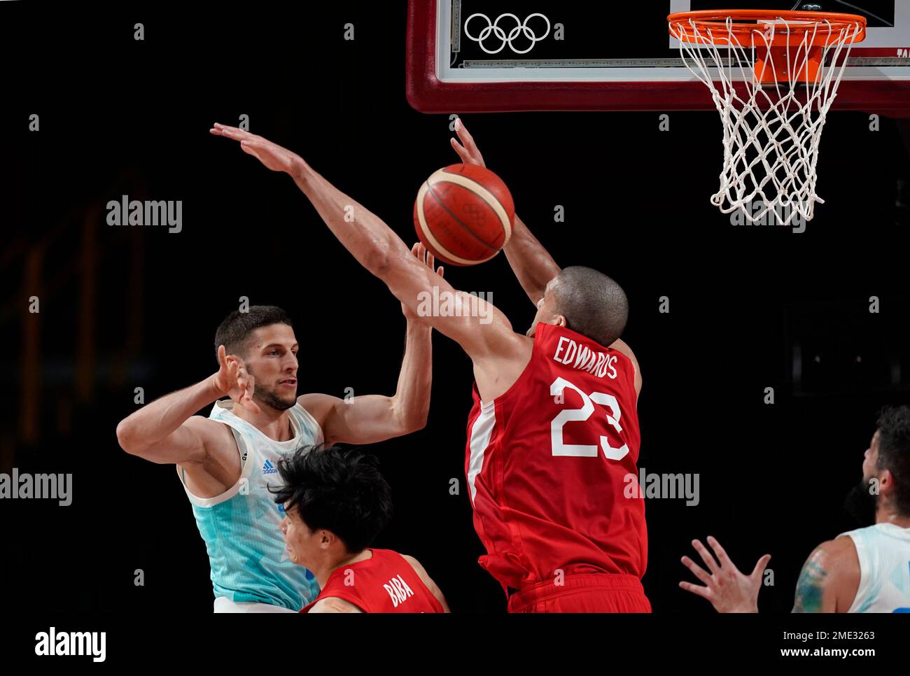 Slovenia's Aleksej Nikolic (6), left, passes over Japan's Gavin Earl ...