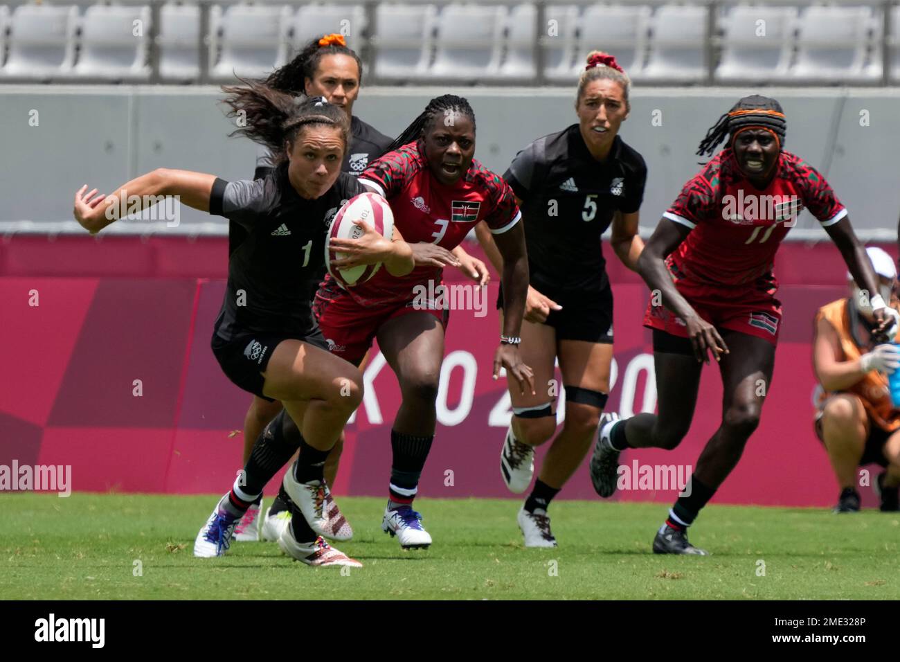 New Zealand's Ruby Tui, left, runs with the ball, pursued by Kenya's ...