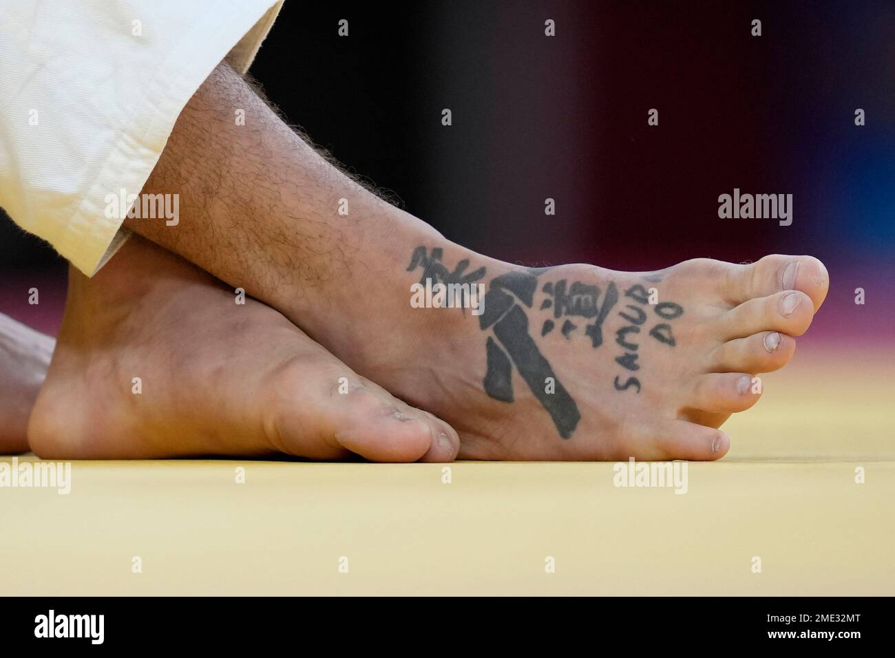 A tattoo with the characters for "Judo" can be seen on the foot of ...