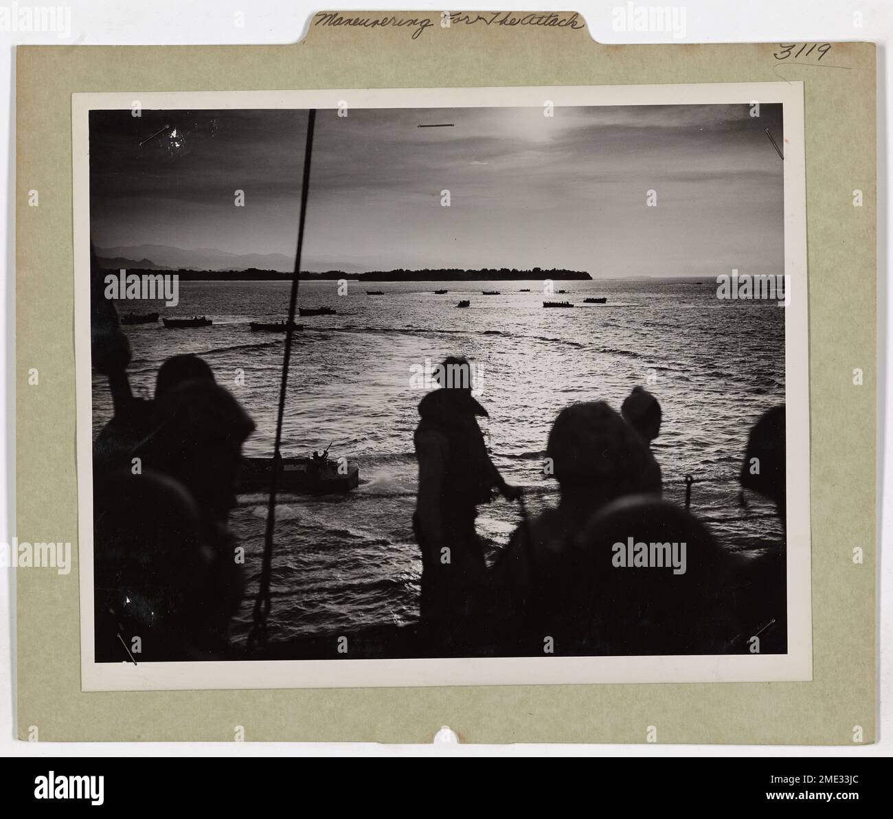 Coast Guardsmen maneuver landing craft filled with Marine troops ...