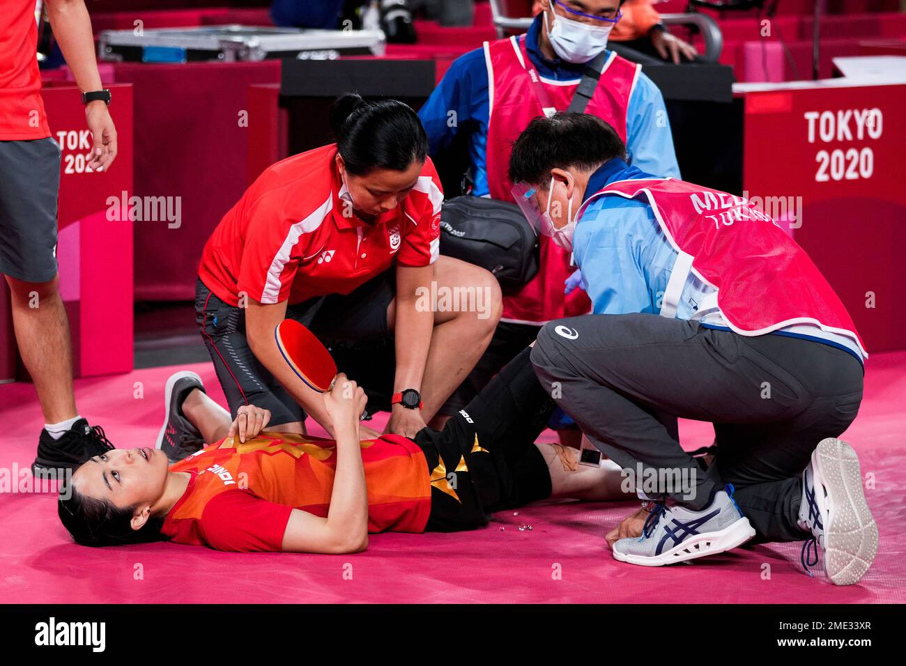 Singapore's Yu Mengyu receives medical treatment during her table ...