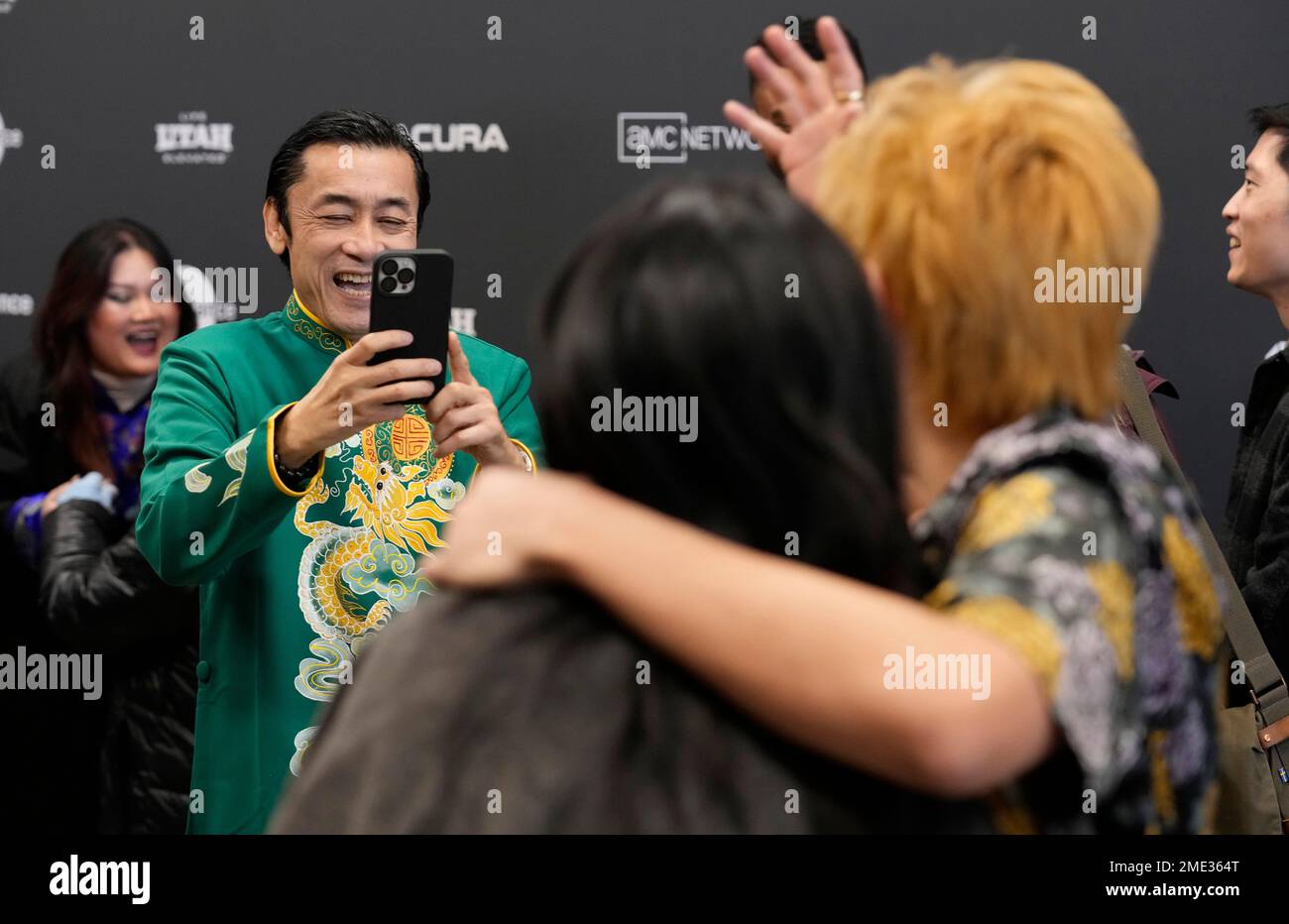 Joseph Hieu, left, a producer of "The Accidental Getaway Driver," takes a picture of cast ...