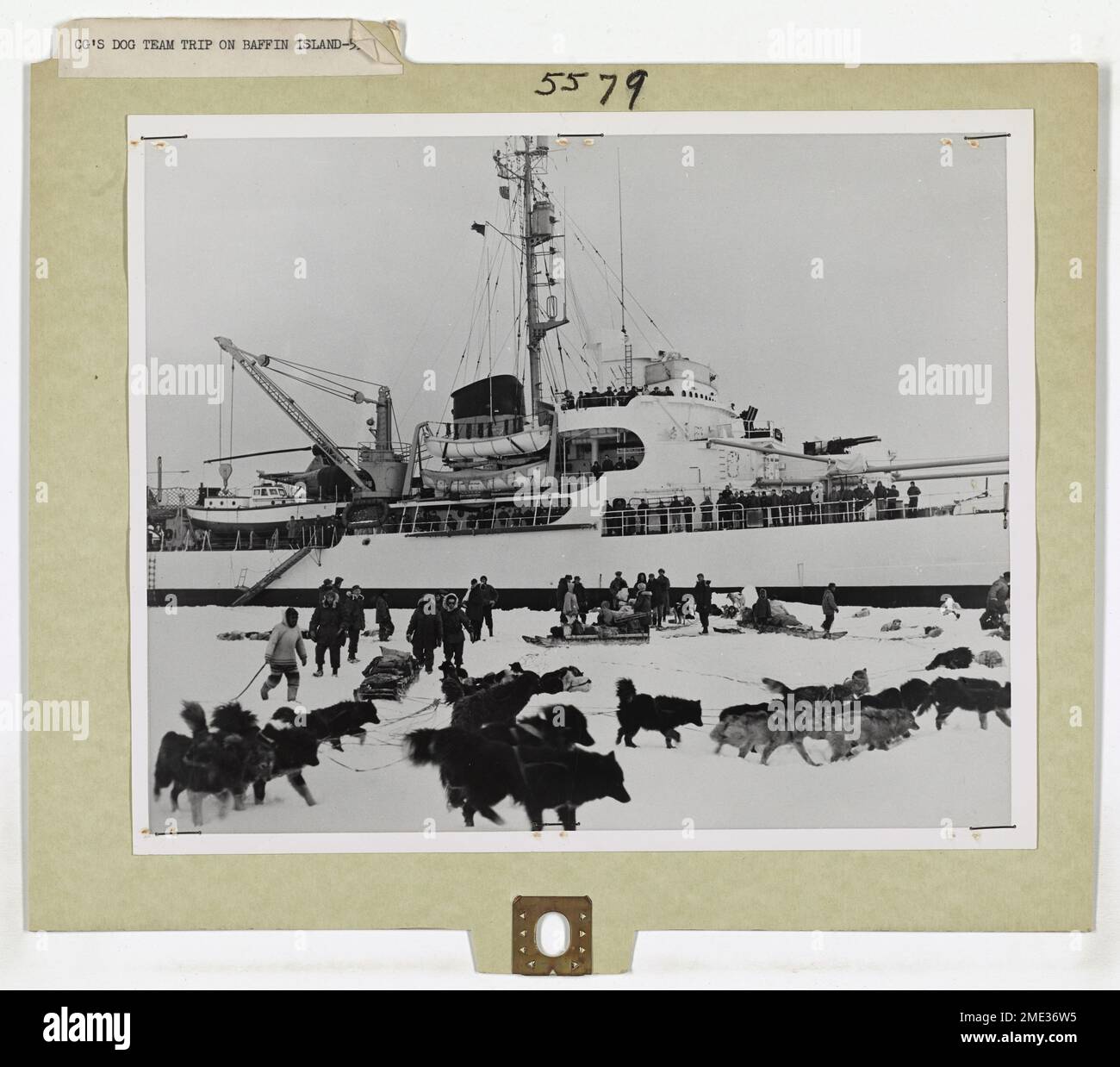 Coast Guard personnel aboard the icebreaker Eastwind observe a dog team ...