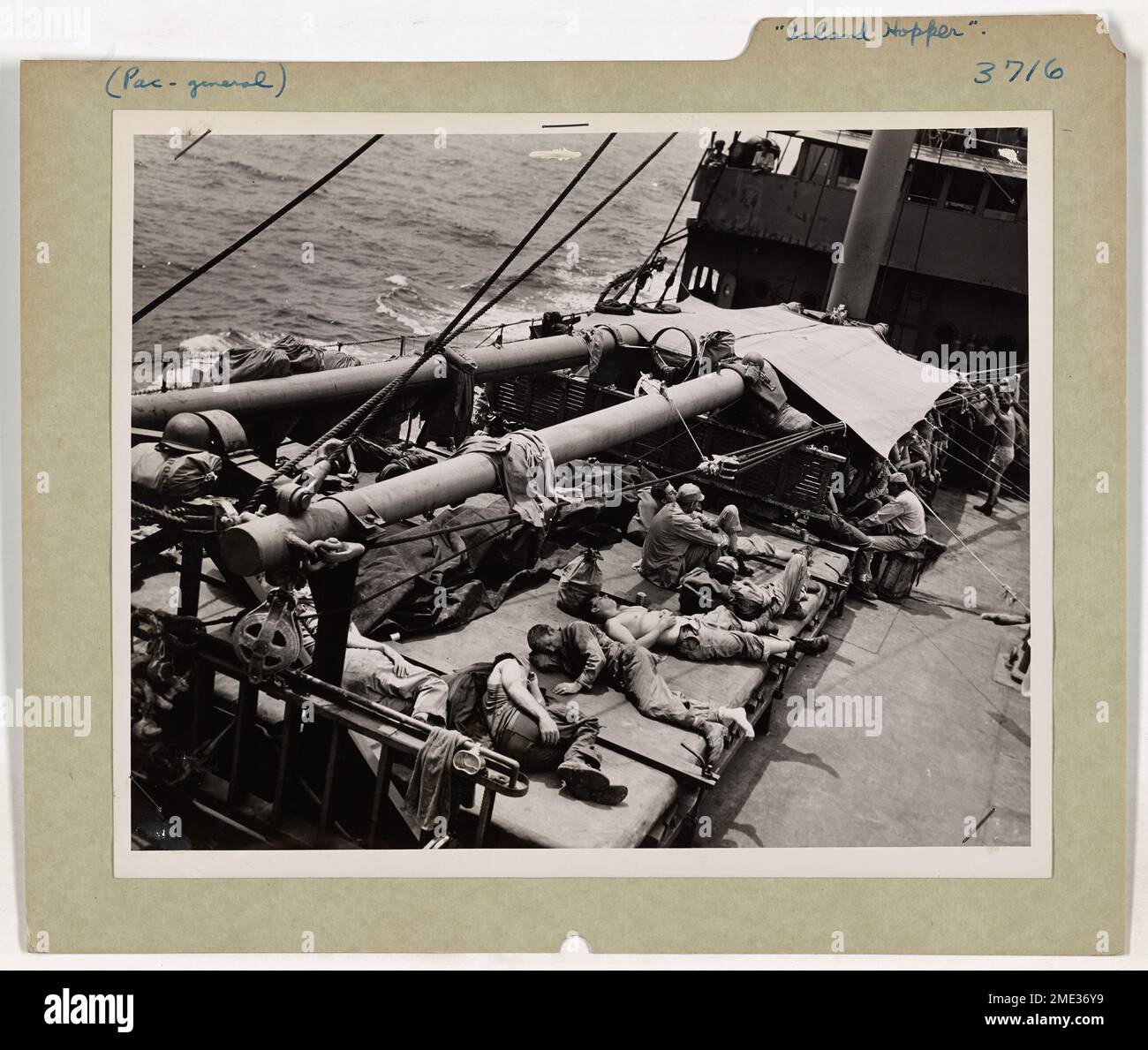 Coast Guardsmen aboard an Army FS (Freight Supply) vessel relax during ...