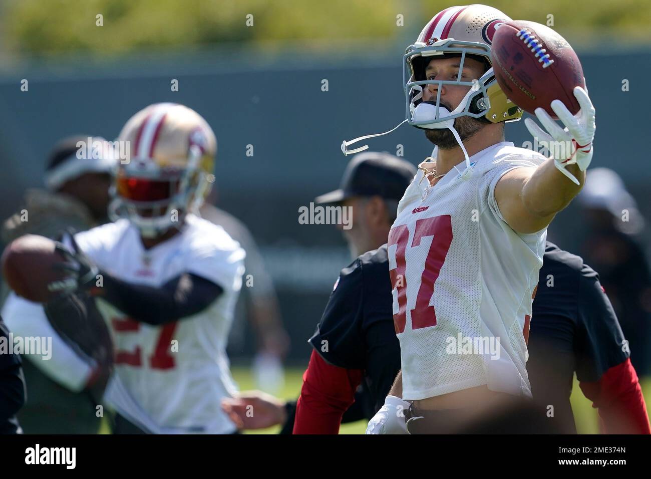San Francisco 49ers defensive end Nick Bosa, right, catches a ball at ...