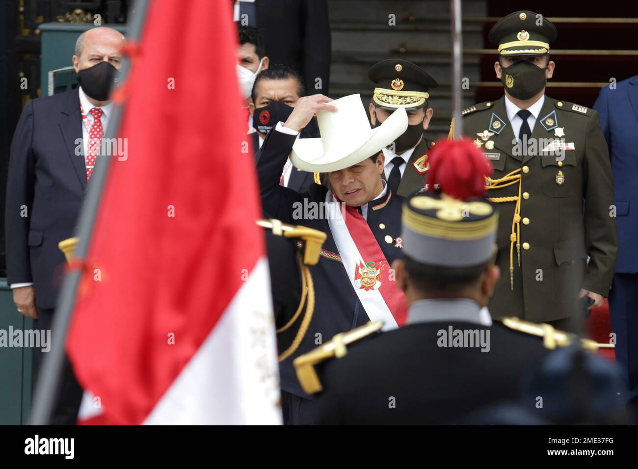 Peru's newly sworn-in President Pedro Castillo puts his hat back on ...