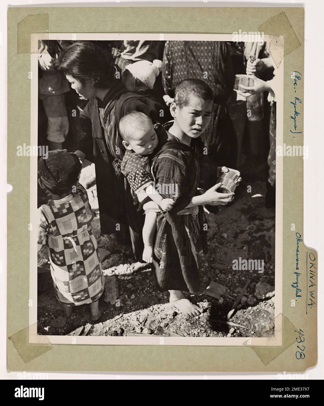 Okinawan children, wearing kimono-style garments, show confusion as ...