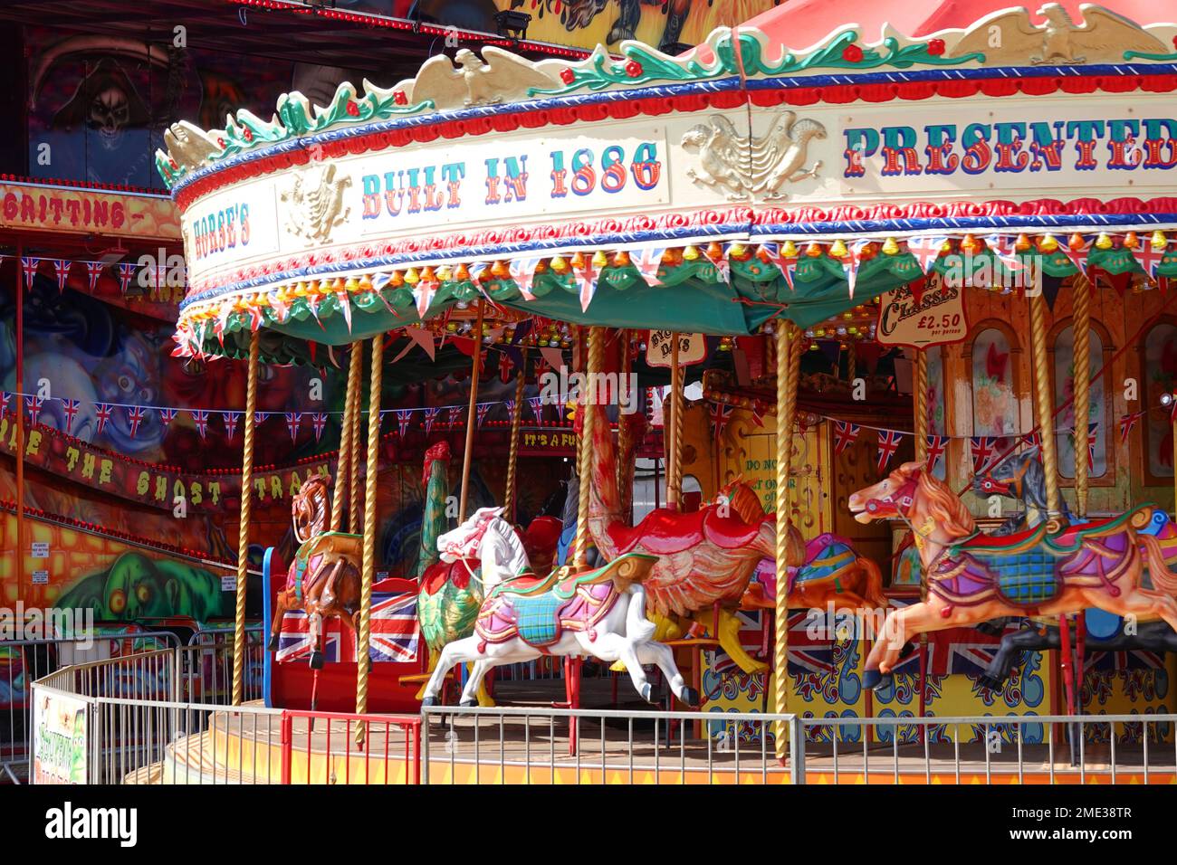 A merry-go-round, or carousel, a traditional British funfair ride Stock ...