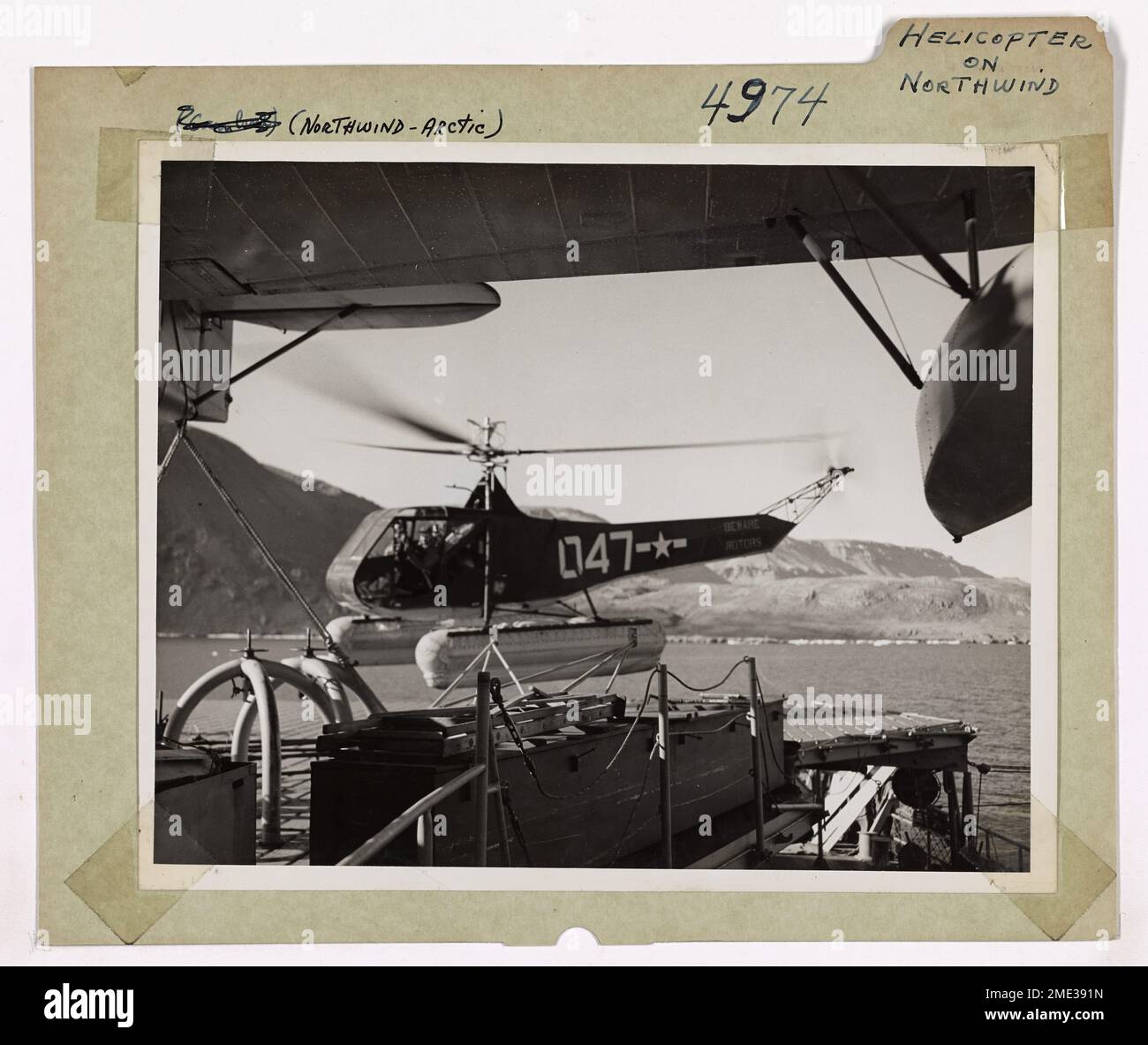 Arctic Exploration Goes Modern. The Coast Guard helicopter is framed by ...