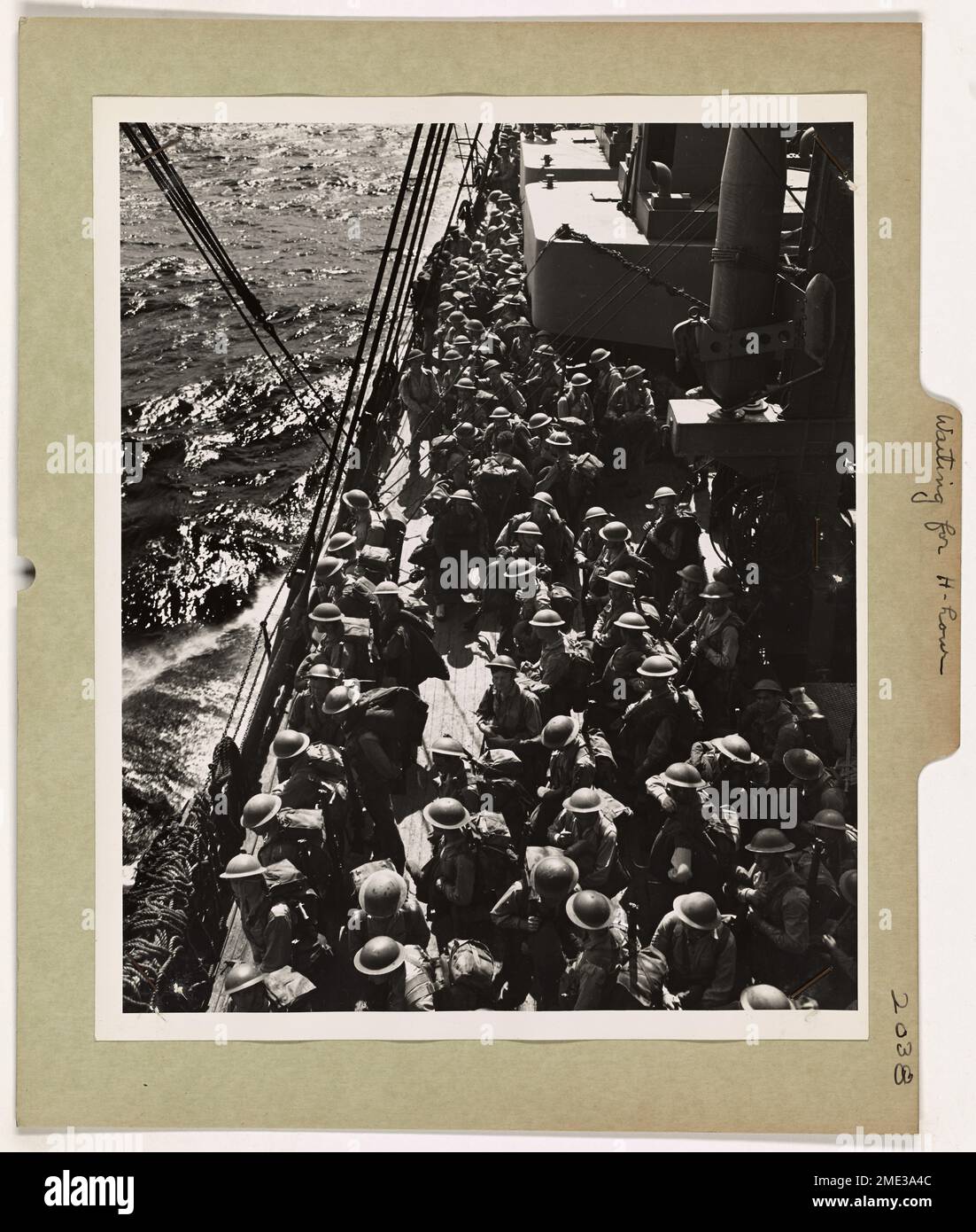 British soldiers aboard a Coast Guard-manned transport wait to board ...