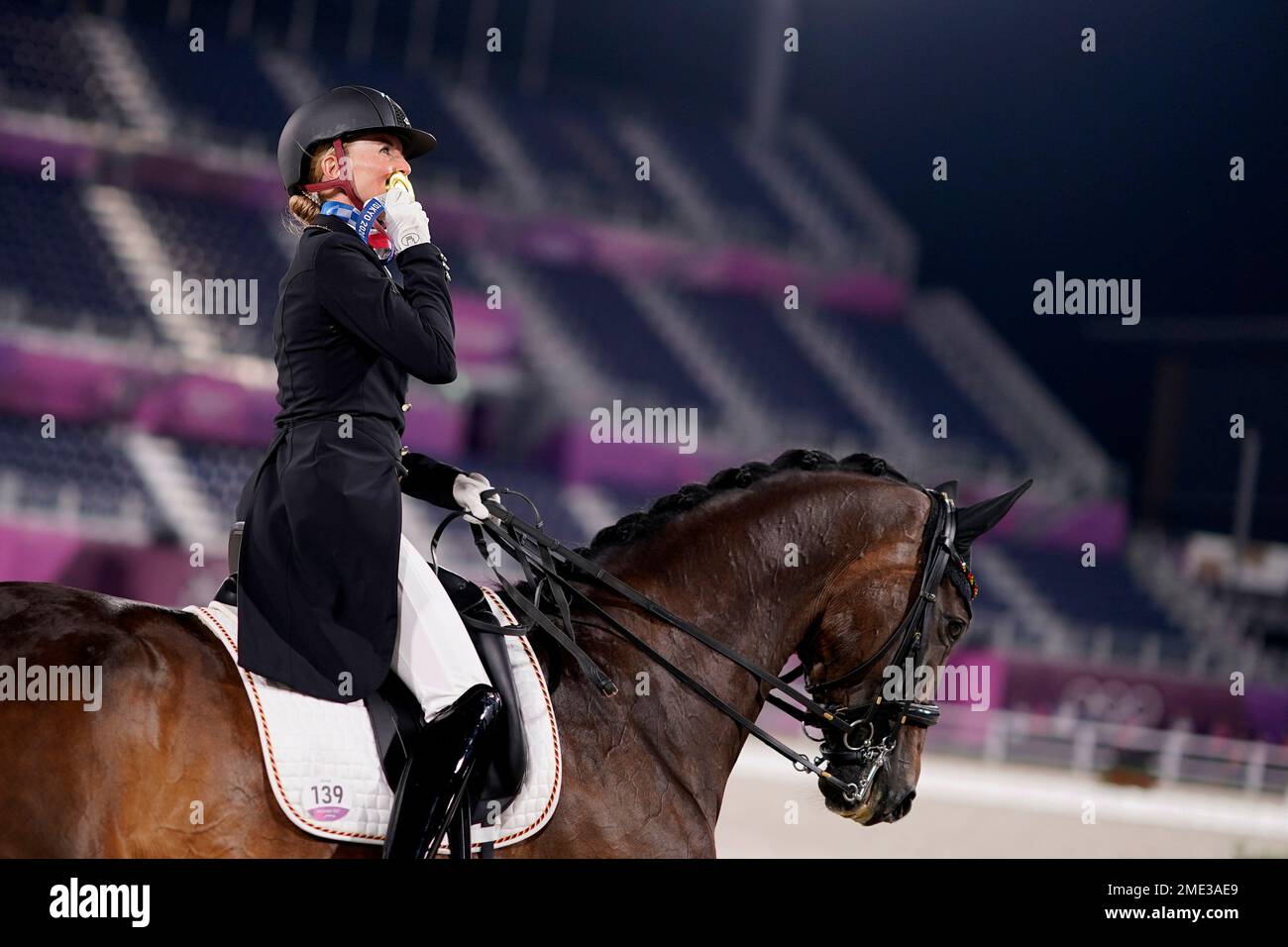 Germany's Jessica von Bredow-Werndl, riding TSF Dalera, kisses her gold ...
