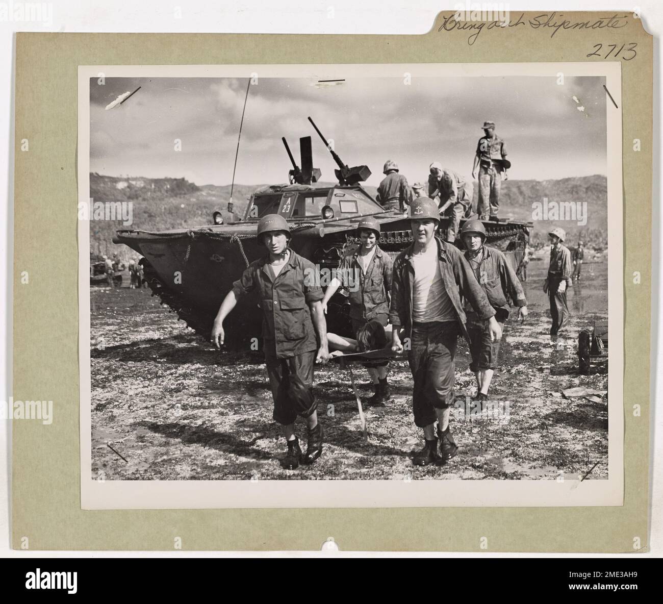 Four Coast Guardsmen carry their wounded shipmate on a litter to be ...