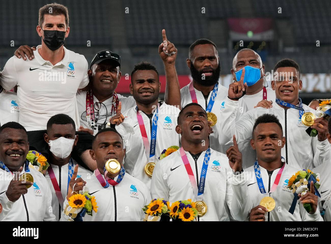 Fiji's players celebrate on the podium with their gold medals in men's ...