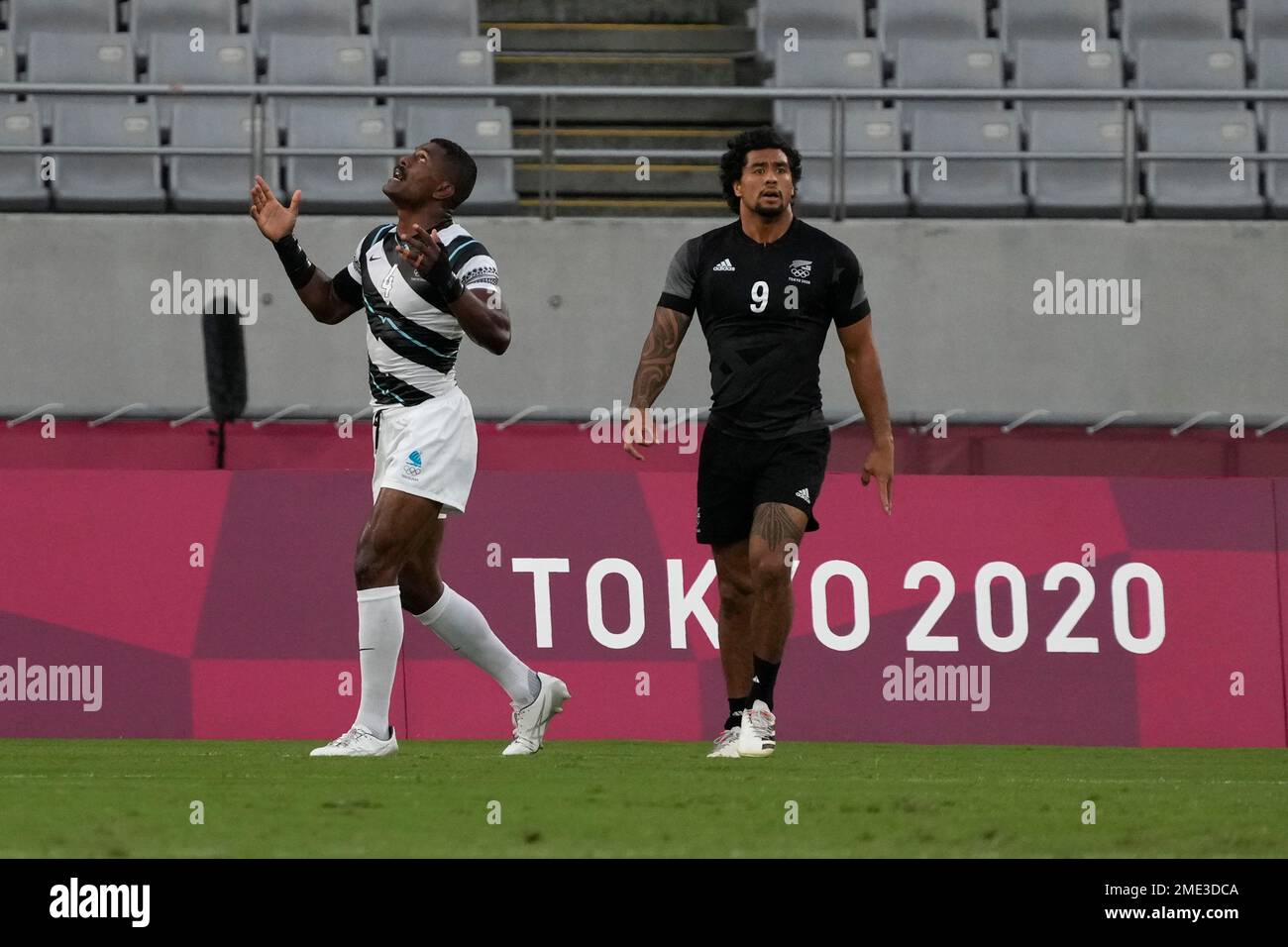 Fiji's Jiuta Wainiqolo, left, reacts after scoring a try, while New ...