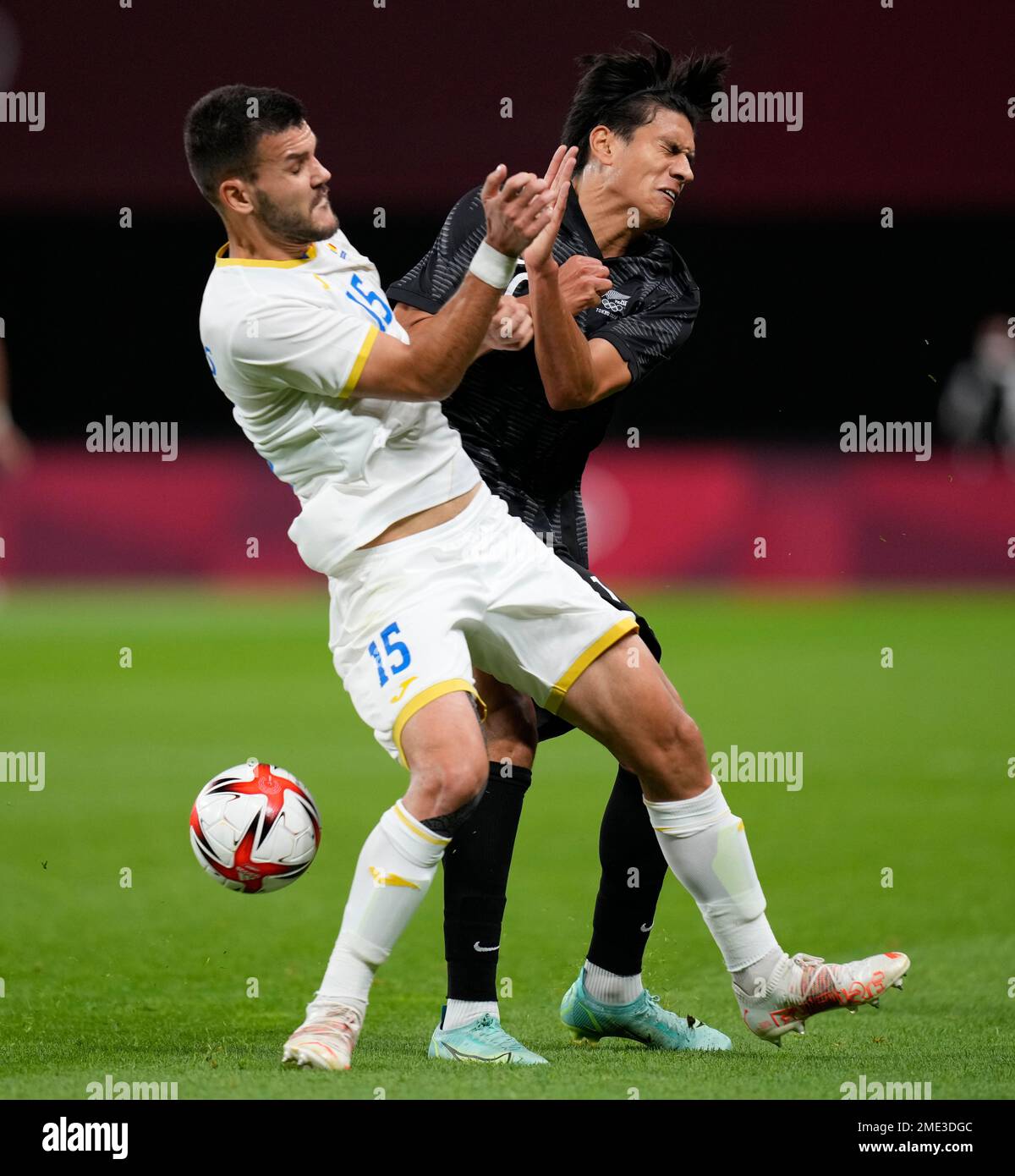 Romania 's Andrei Ciobanu (15) and New Zealand's Marko Stamenic fight ...