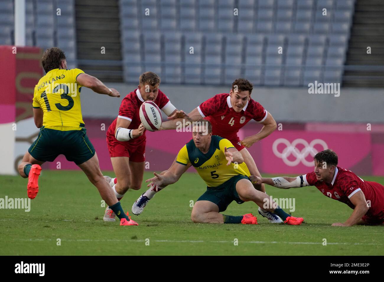 Australia's Lachie Miller, center, passes to Australia's Lewis Holland ...