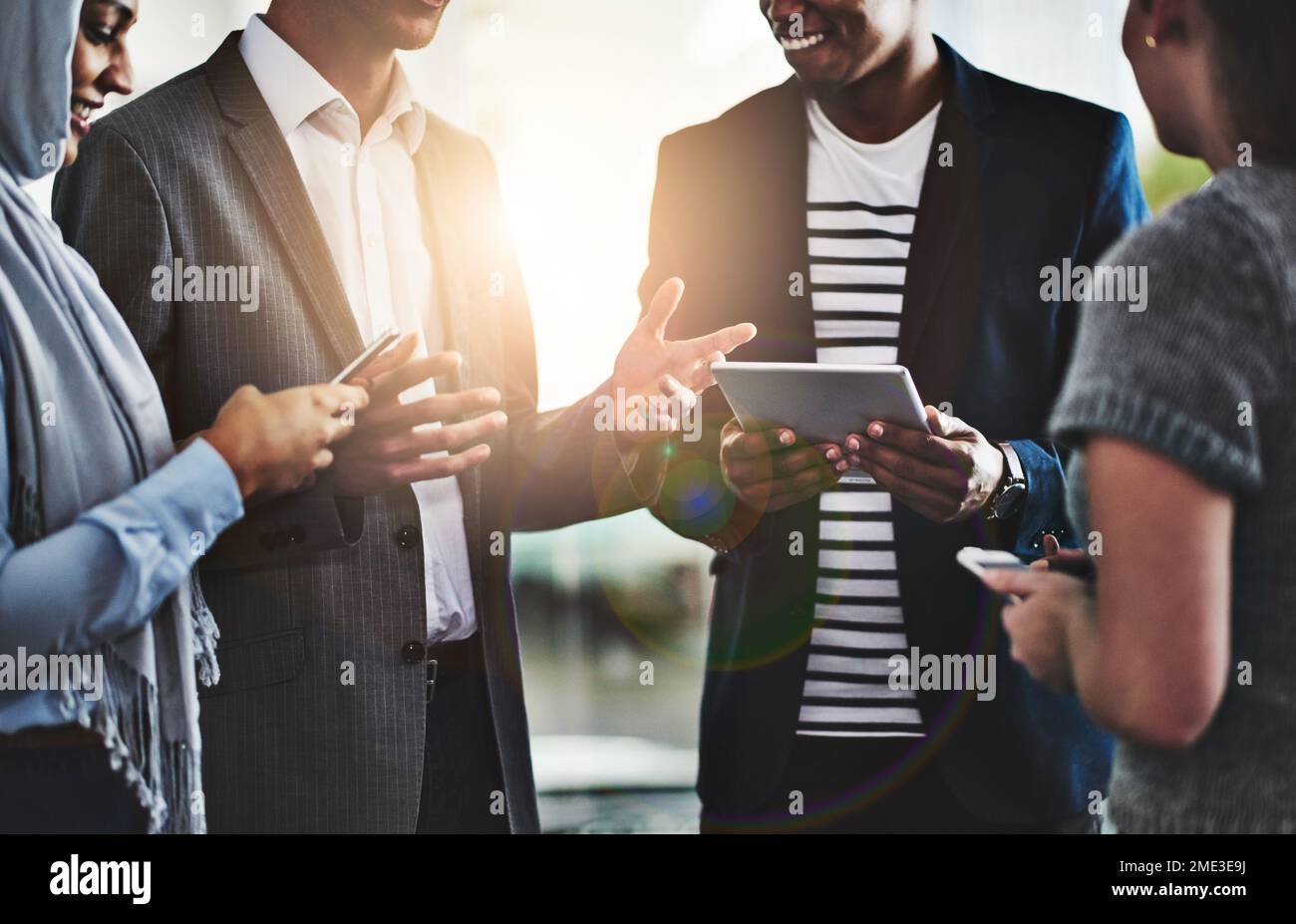 Digital discussion. a group of unrecognizable businesspeople browsing ...