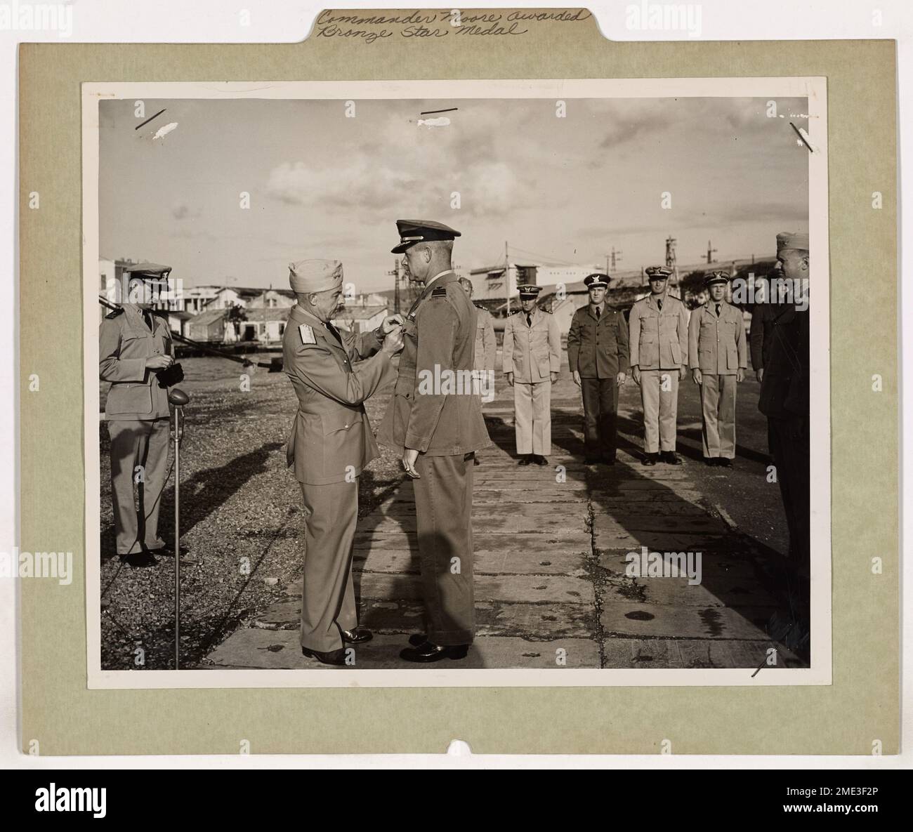 Commander Harold C. Moore is awarded the Bronze Star Medal for ...