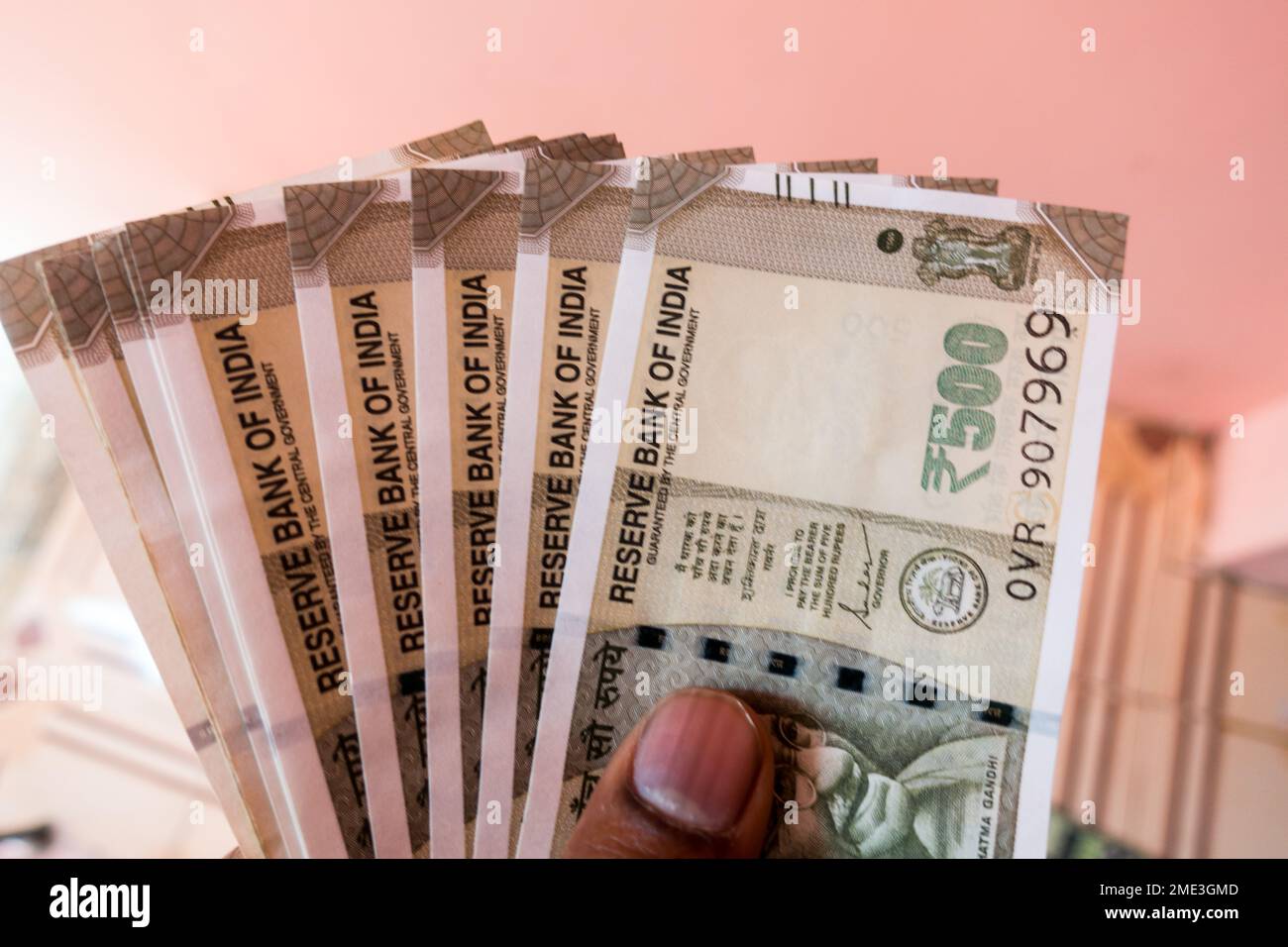 Indian rupees currency in denominations of 500 held by a man Stock ...