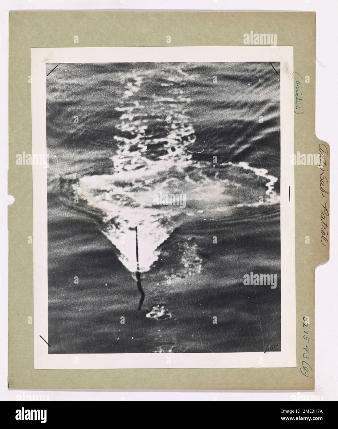 A periscope breaks the water's surface, indicating the presence of a ...