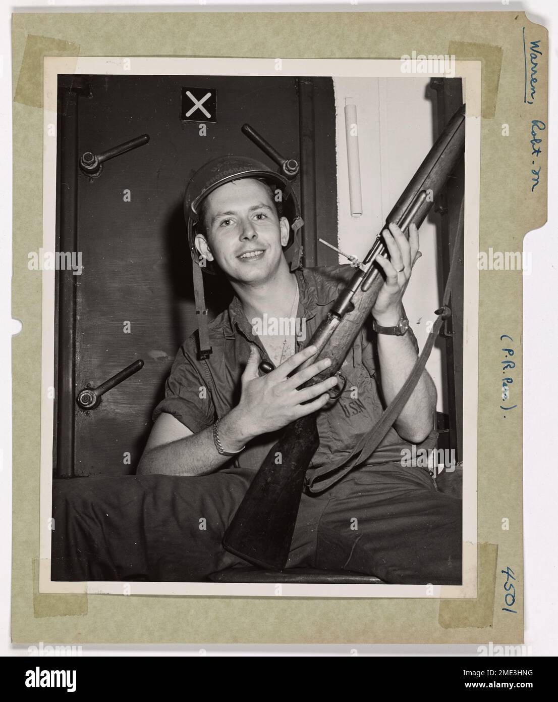 Coast Guard Combat Photographer Robert M. Warren is pictured aboard an ...