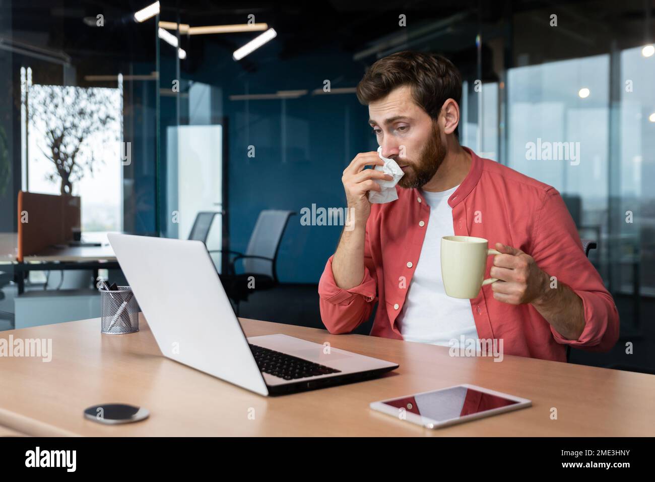 Sick man at work has flu and cold, businessman sneezes and coughs at ...