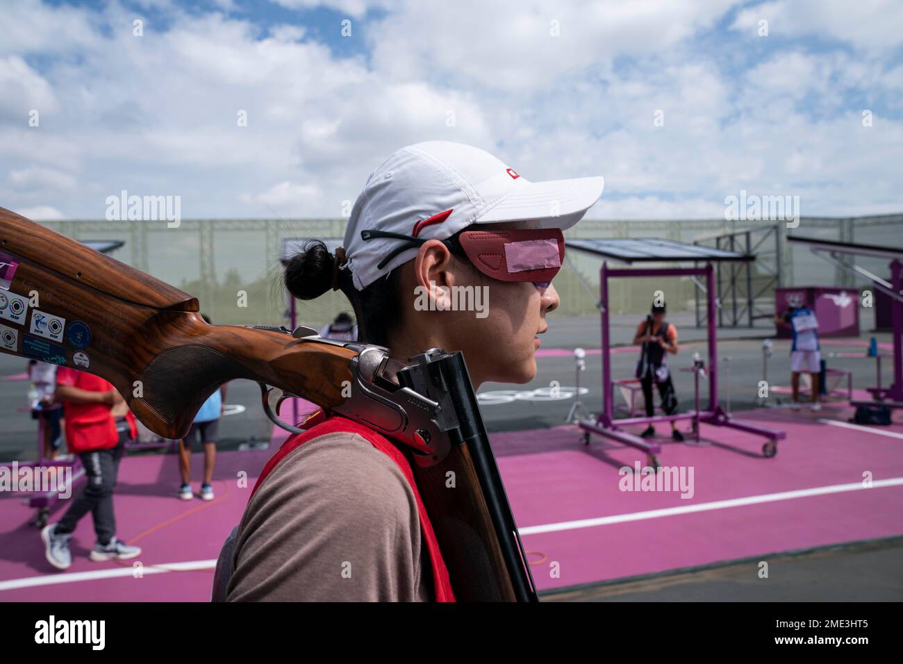 Wang Xiaojing, of China, departs after competing in the women's trap at the Asaka Shooting Range ...