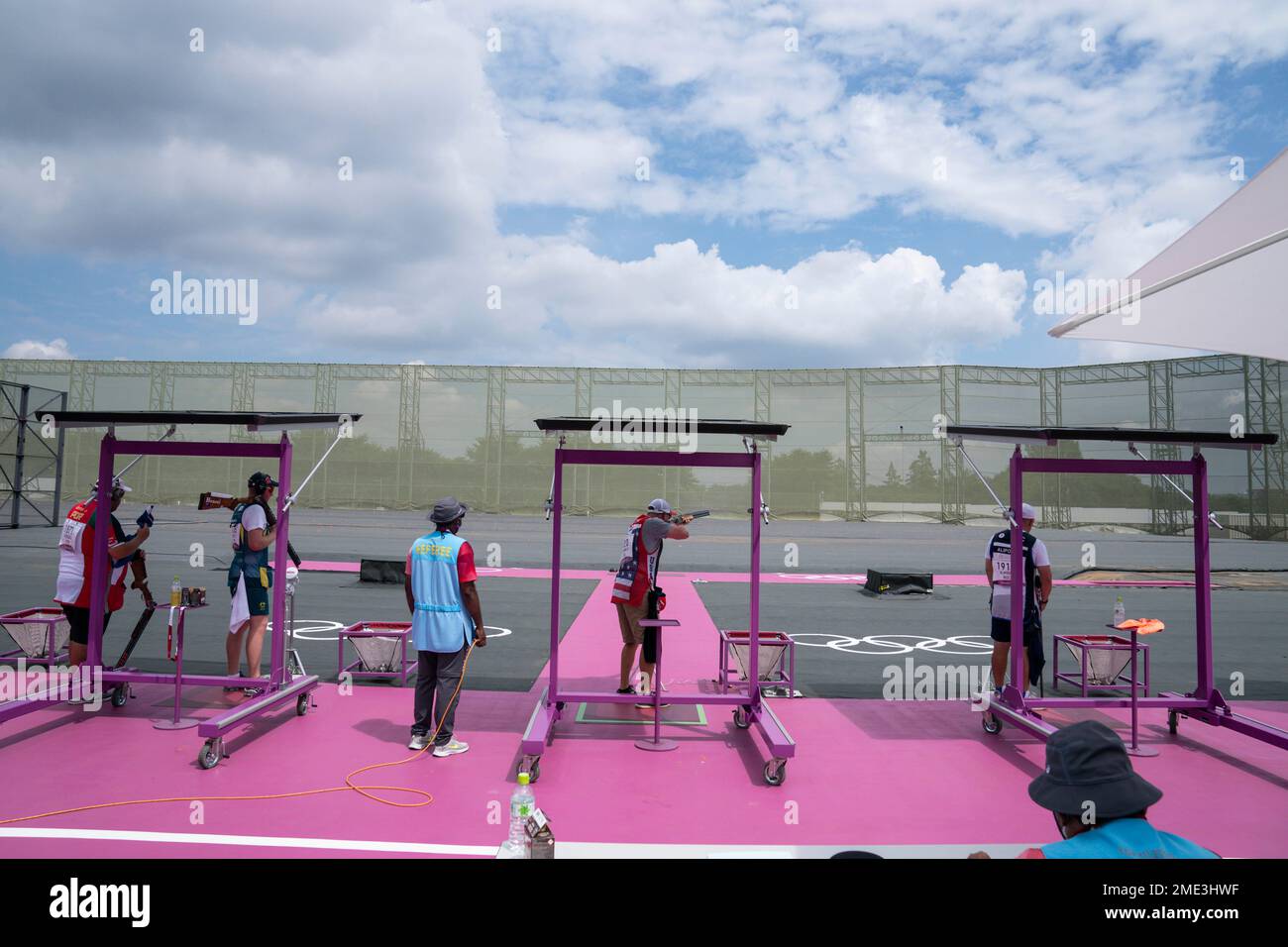 Brian Burrows, center, of the United States, competes in the men's trap ...