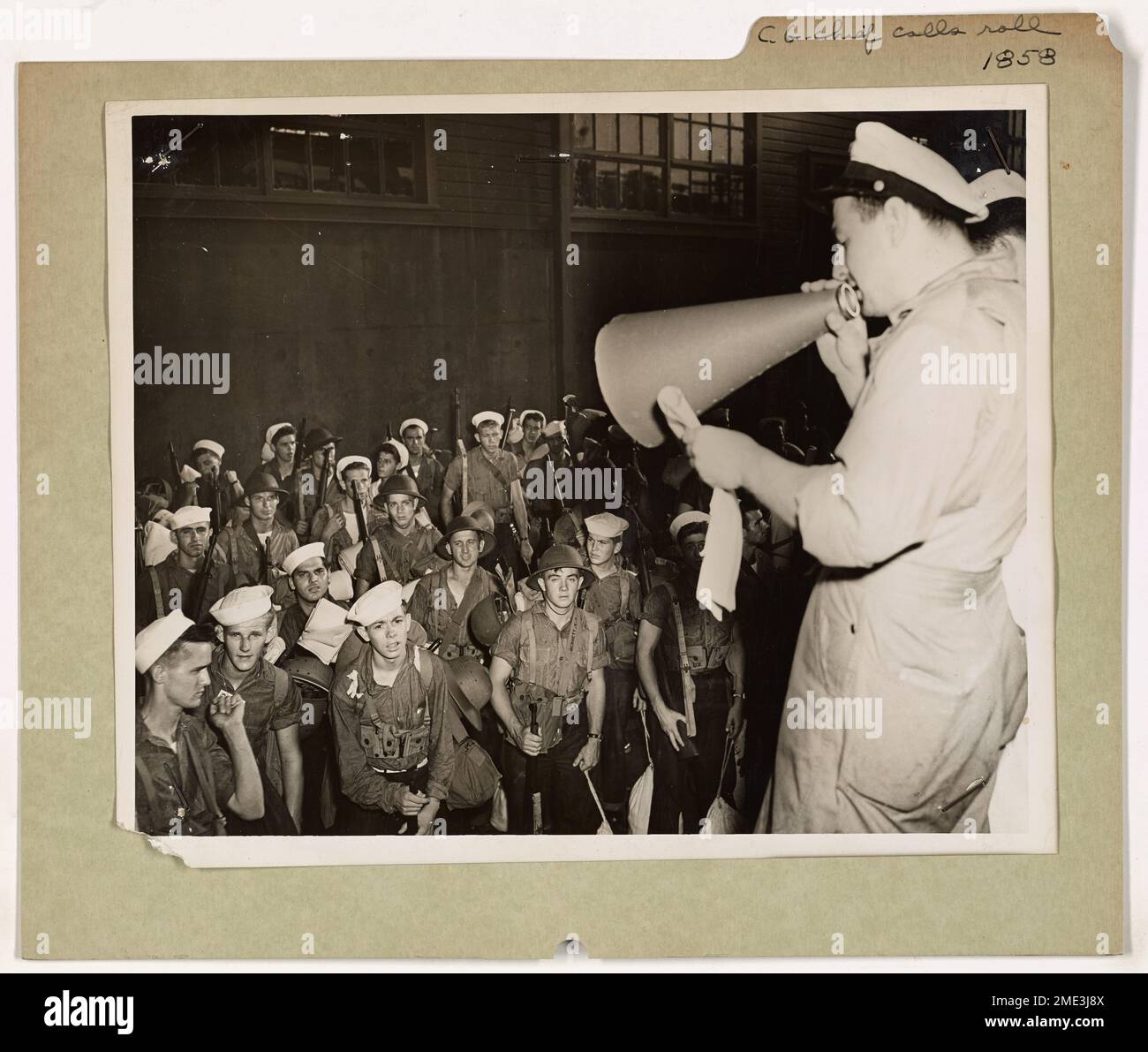 A Coast Guard chief boatswain's mate conducts a roll call aboard a ...
