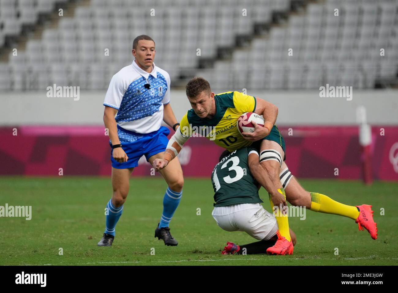 Australia's Nick Malouf charges through South Africa's Ronald Brown, in ...