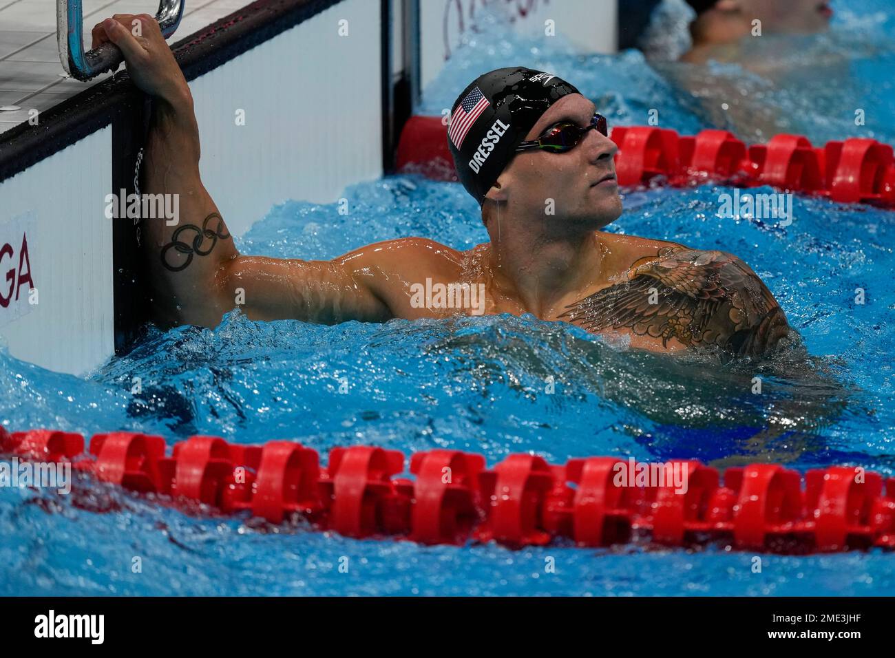 Caeleb Dressel, of the United States, reacts after winning a men's 100 ...