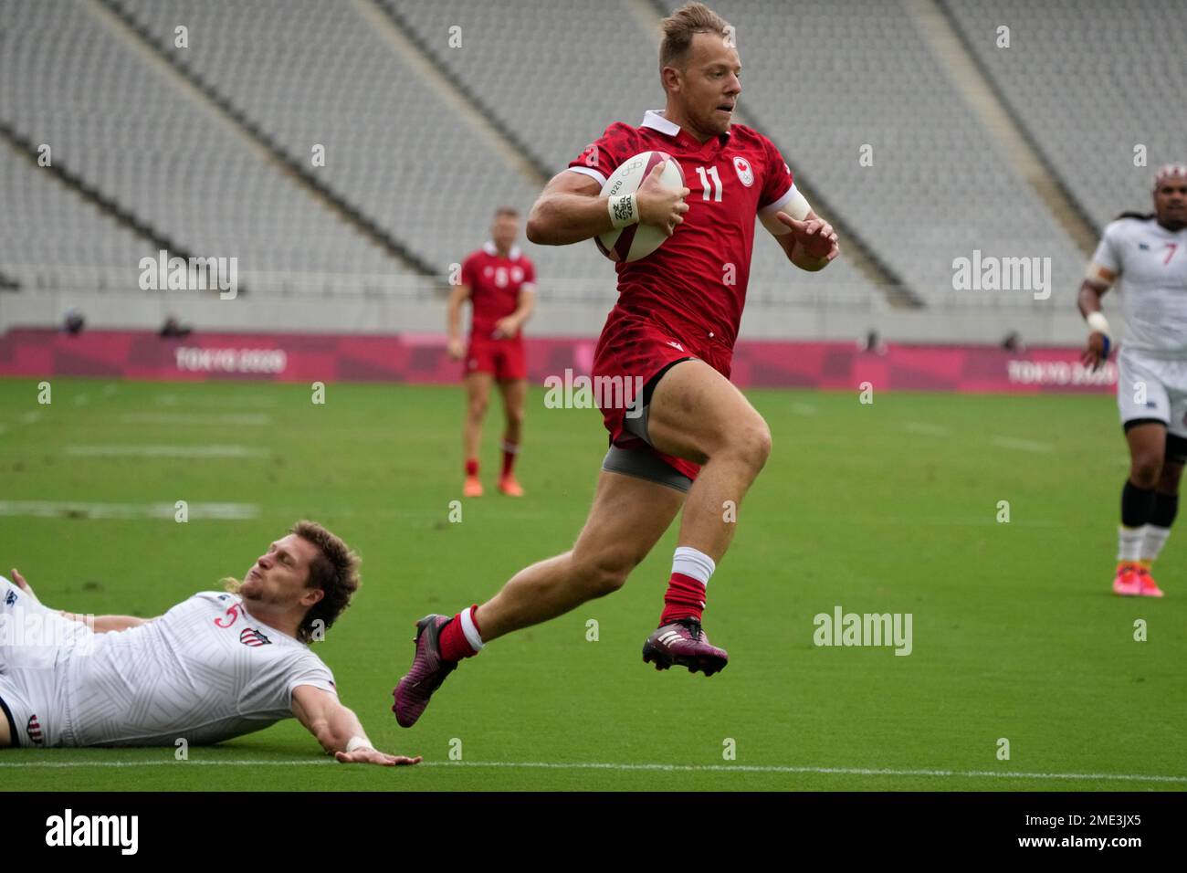 Canada's Harry Jones gets past Joe Schroeder of the United States to ...