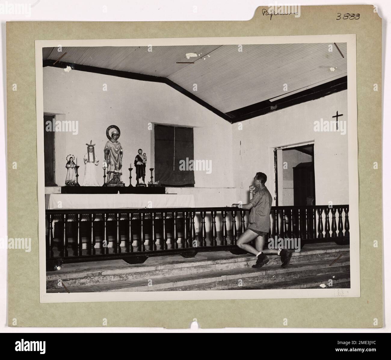 Coast Guard Combat Photographer John Papsun kneels in the historic ...
