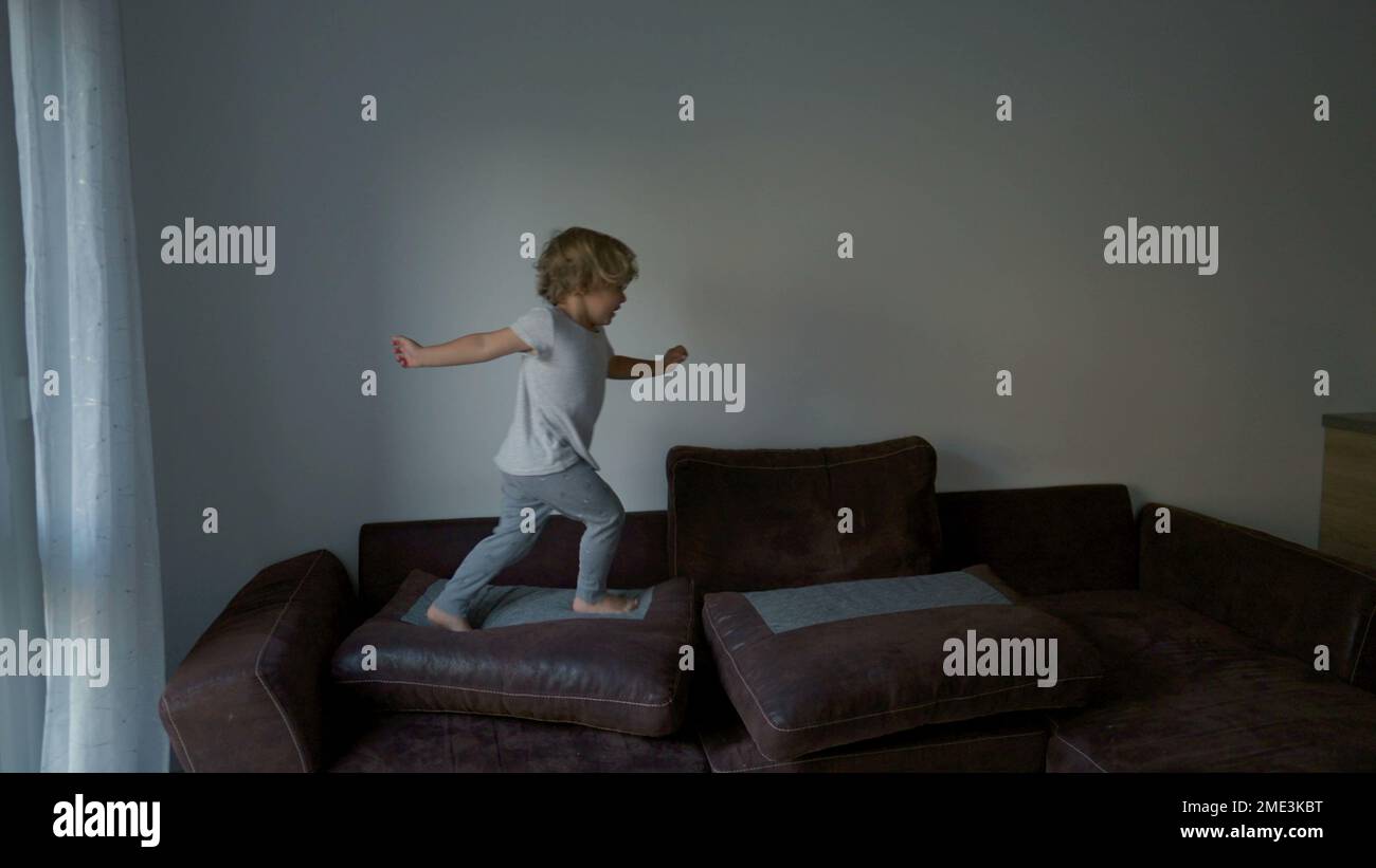 Little boy jumping on sofa hi-res stock photography and images - Alamy