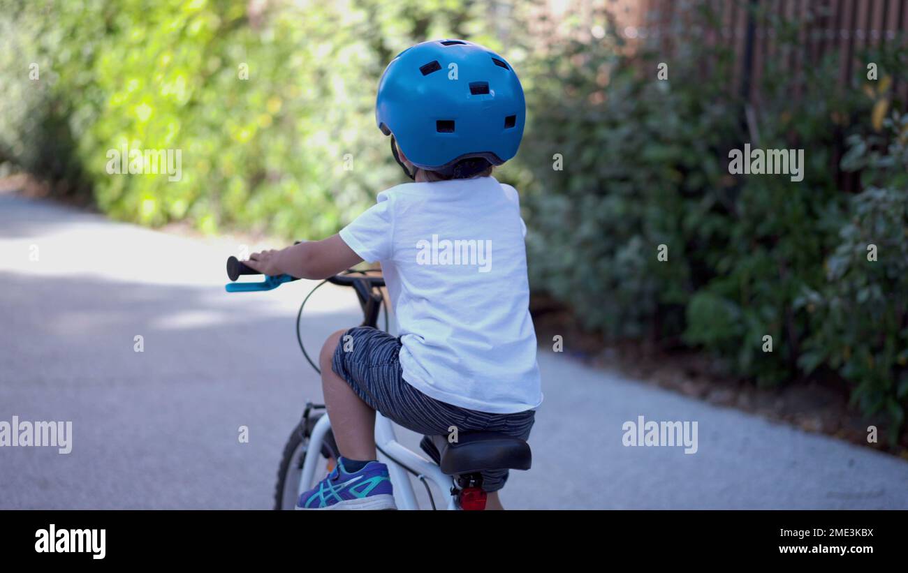 Active little boy riding bicycle outside child rides bike Stock Photo ...