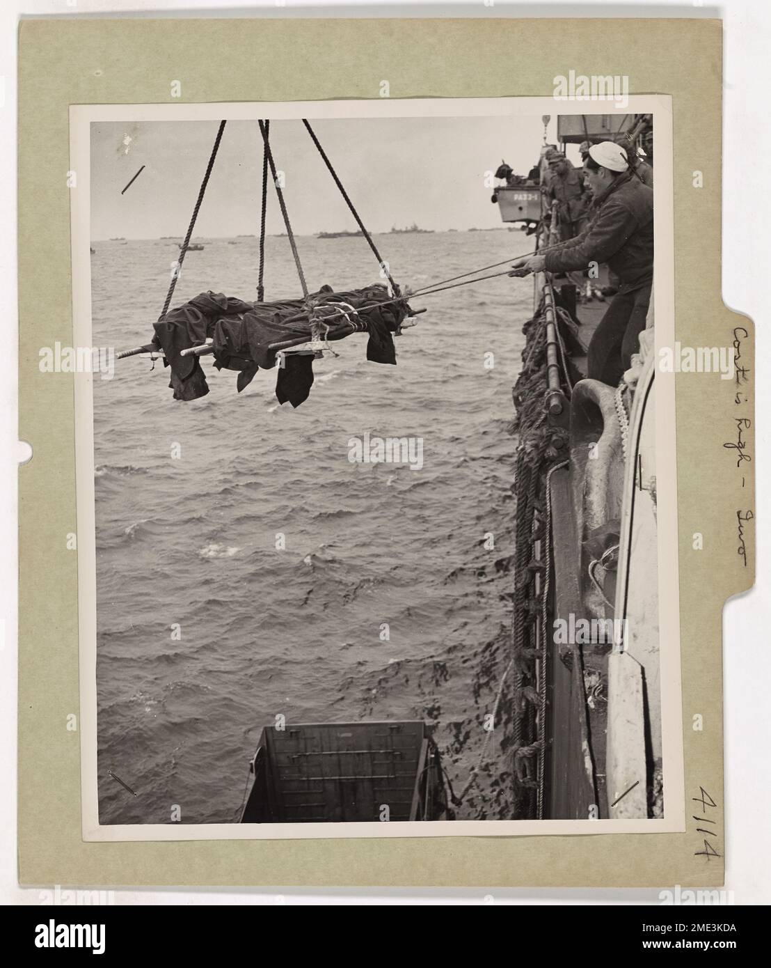 Cost Is High At Iwo Jima. This image depicts casualties being hoisted ...