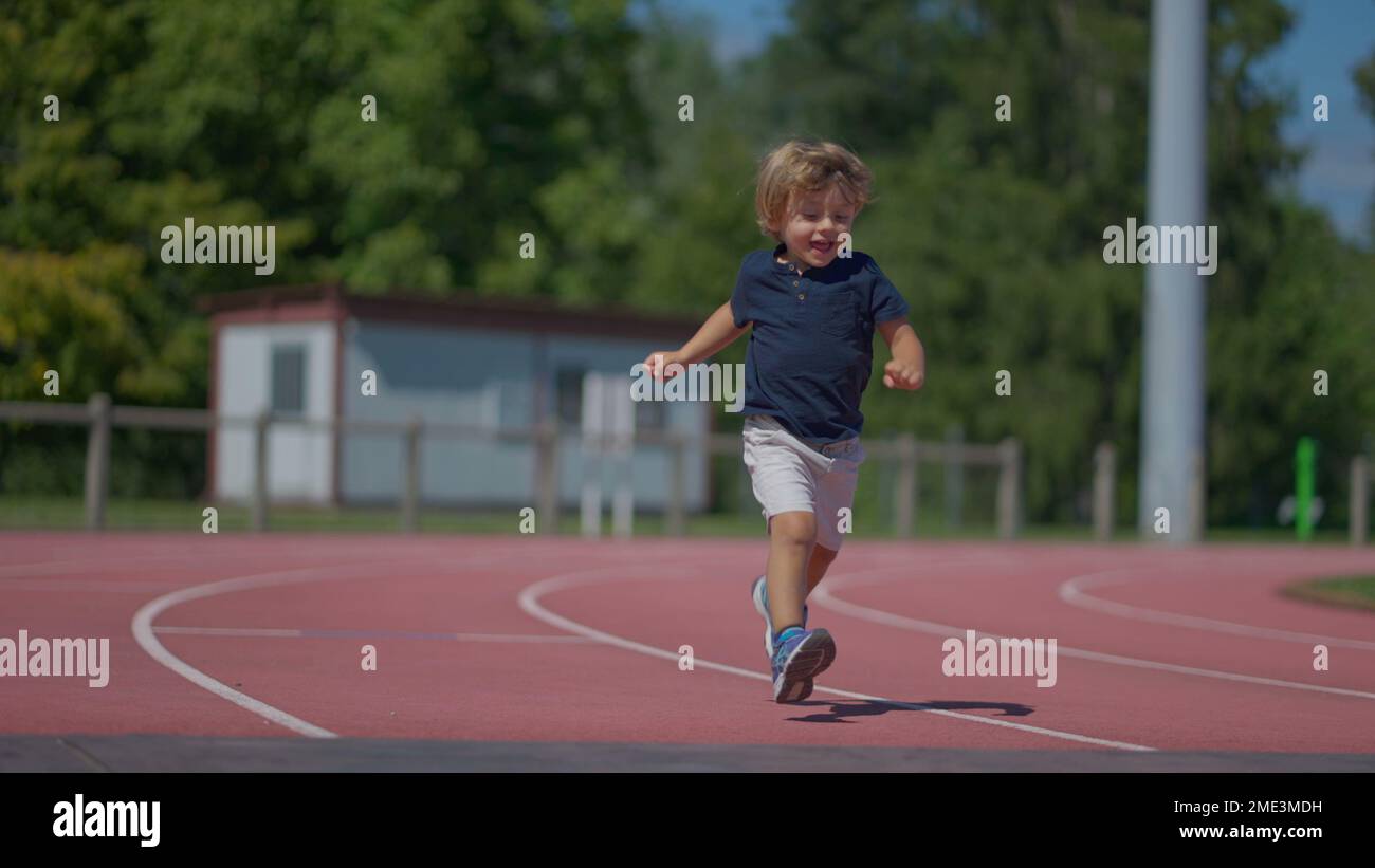 Little boy runner on running track Stock Photo - Alamy