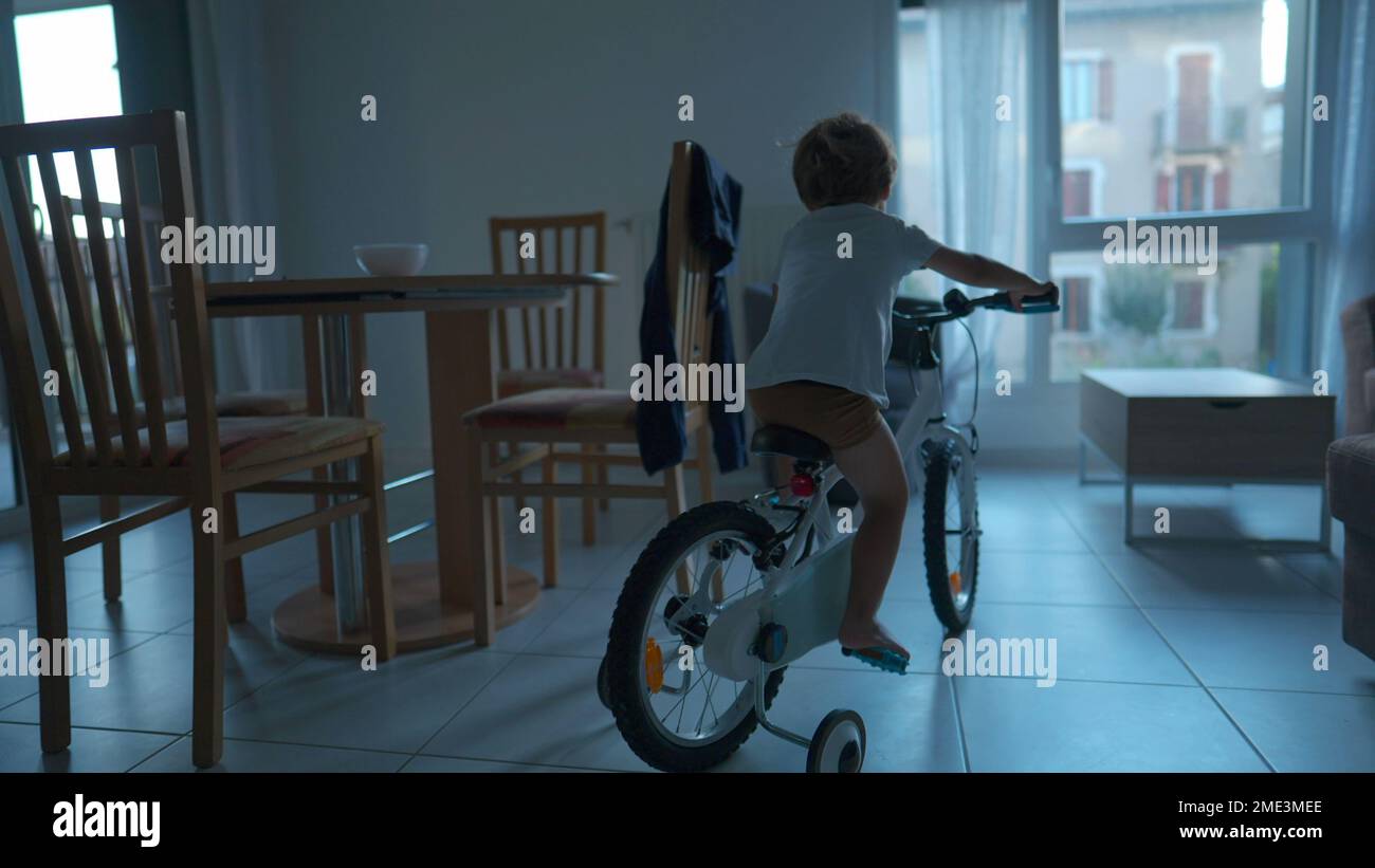 Little boy riding bicycle indoors at home, childes bike interior Stock ...