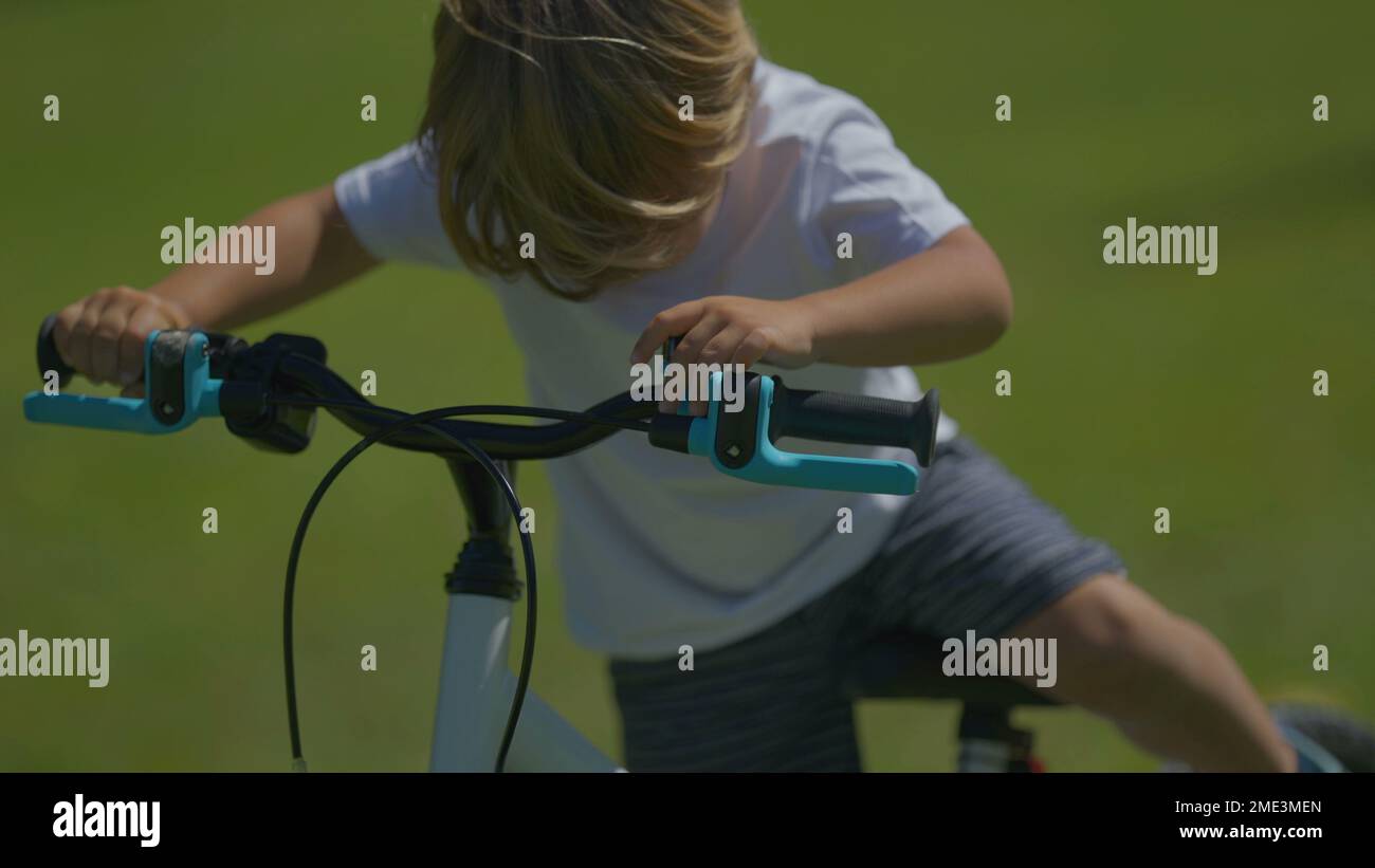 One small boy pushing bicycle child climbing on bike riding Stock Photo ...