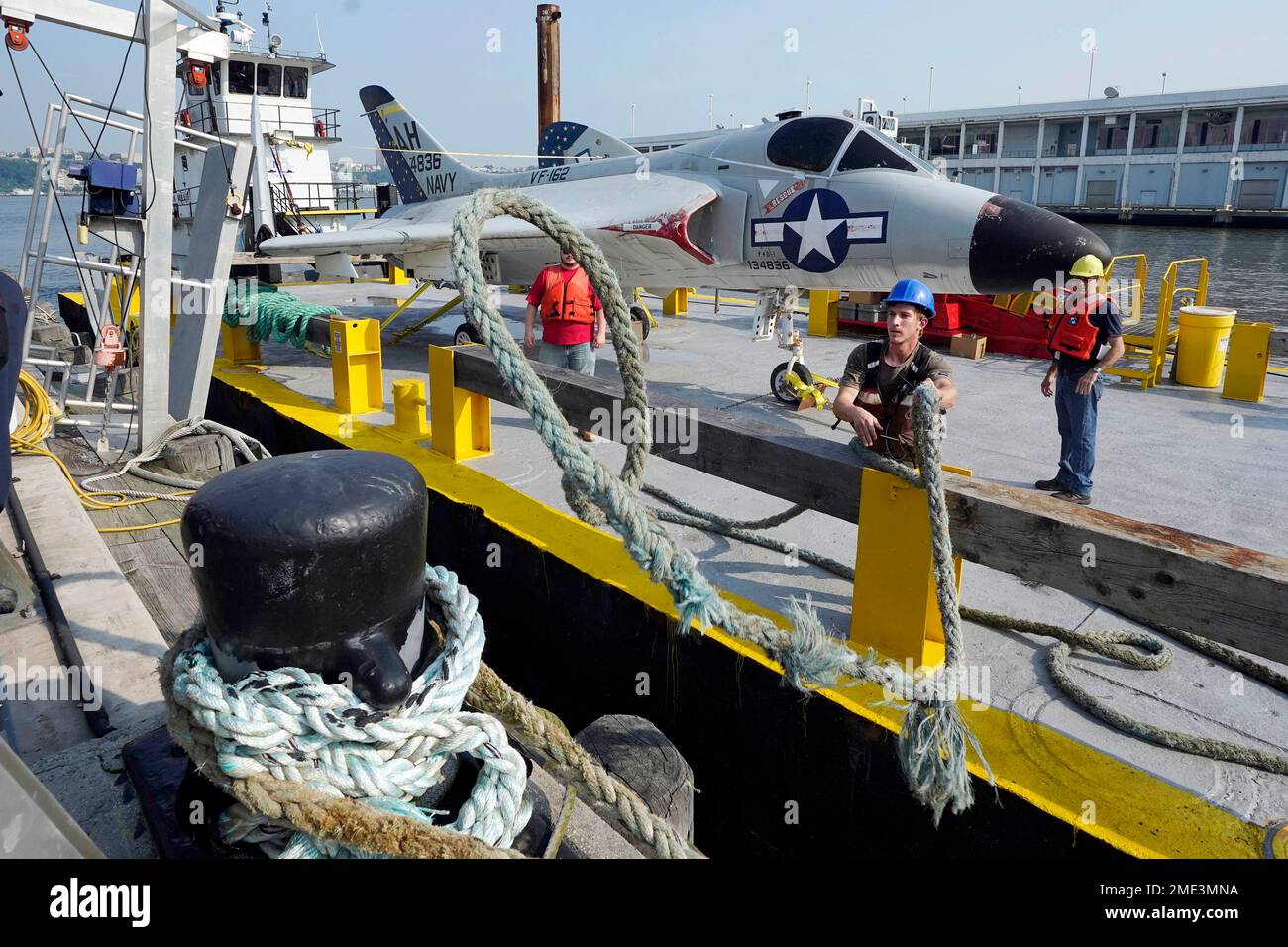Joseph Ternyia, from Miller's Tug & Barge, throws a line to the pier as ...